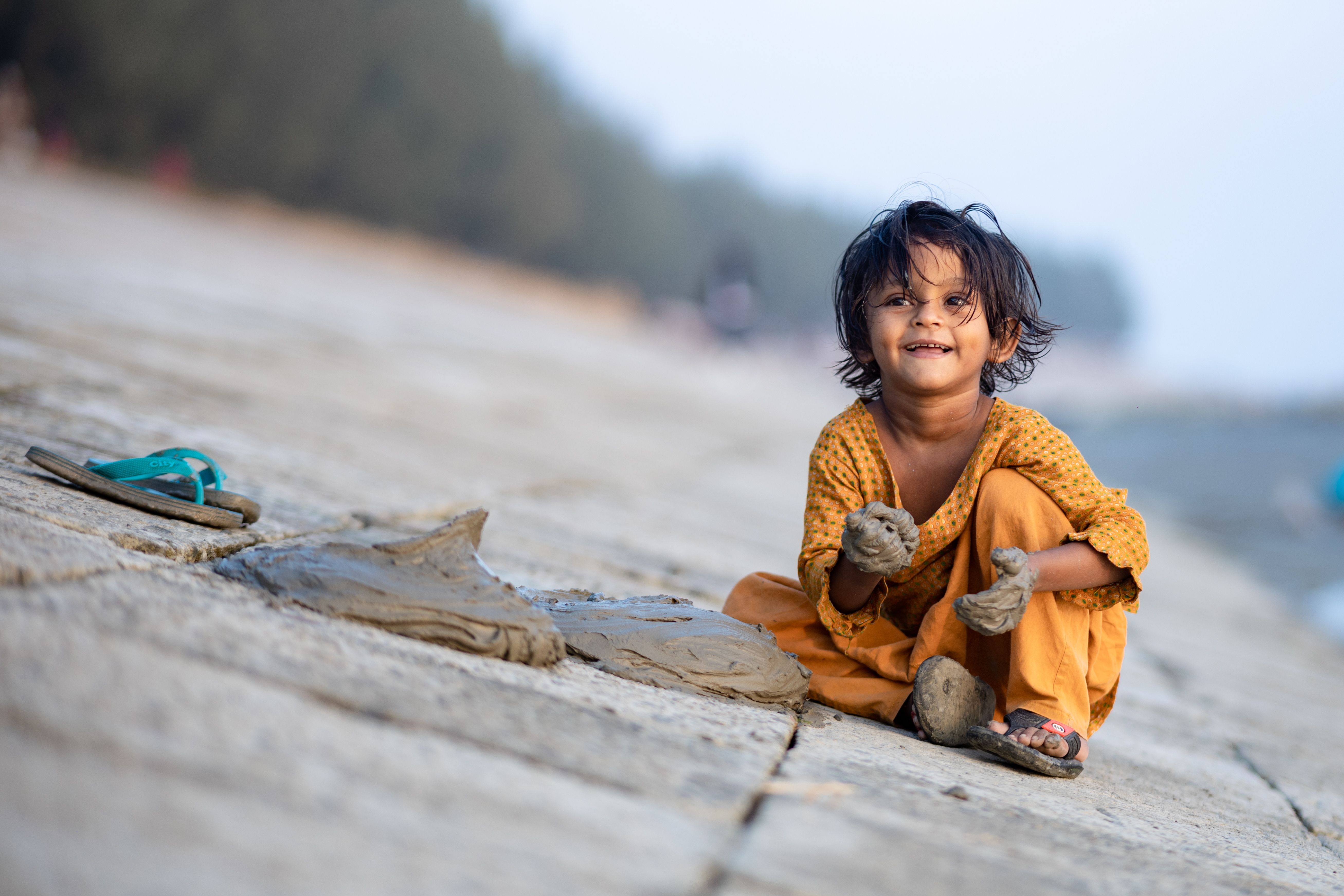 Joyful Child Playing with Mud Outdoors · Free Stock Photo