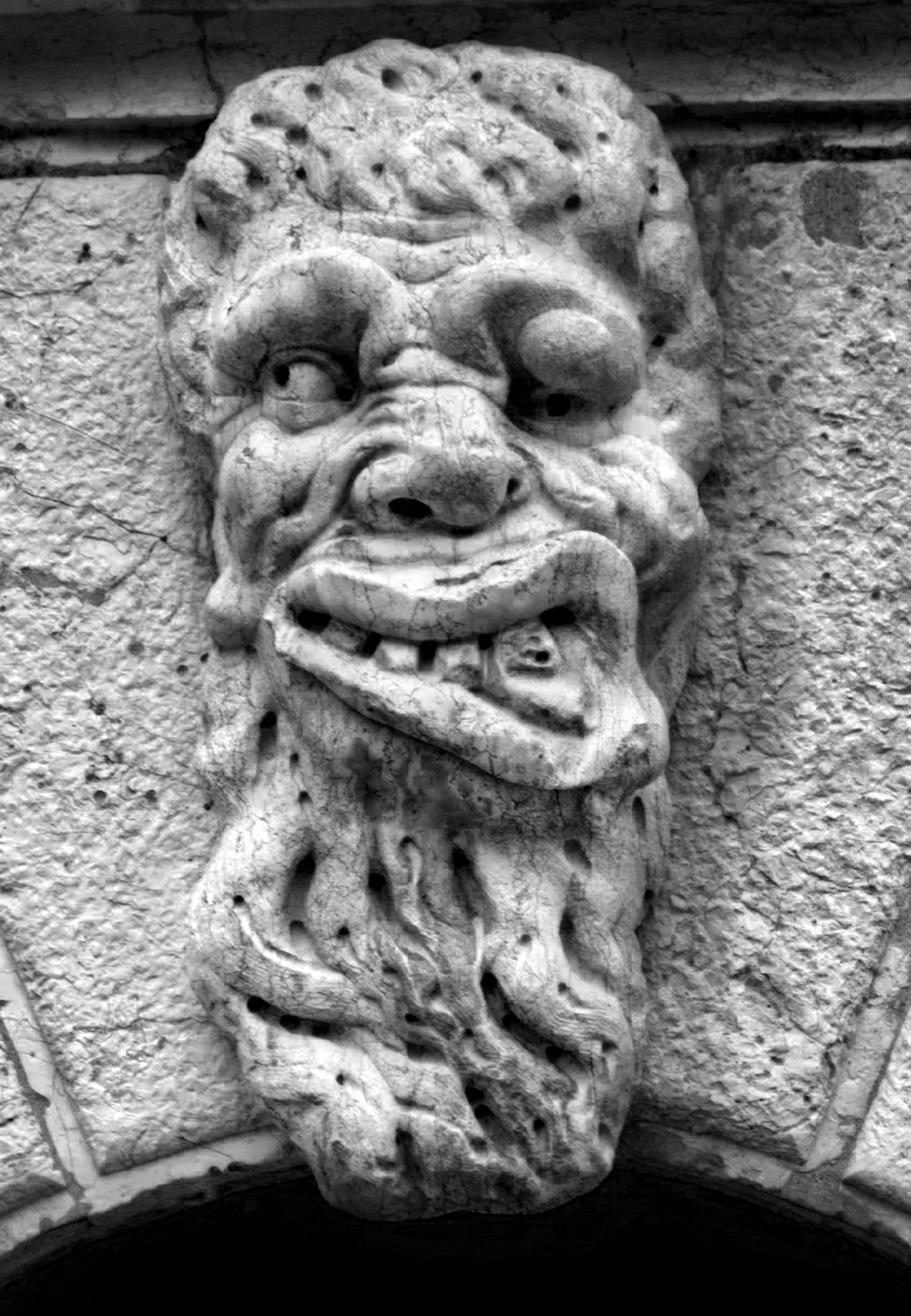 Stone Gargoyle Face on Historic Building Facade · Free Stock Photo