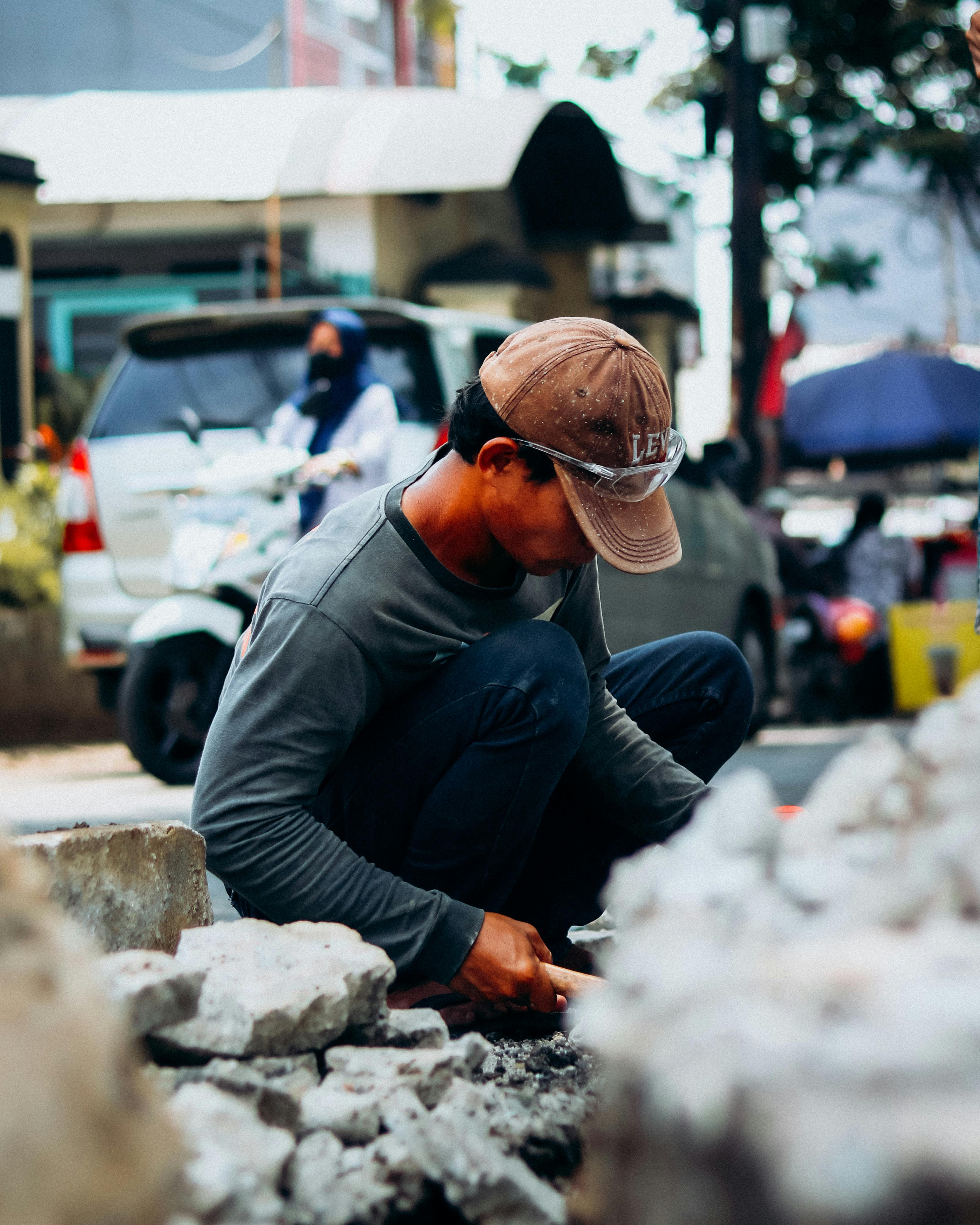 Urban Street Worker Fixing Sidewalk in Indonesia · Free Stock Photo