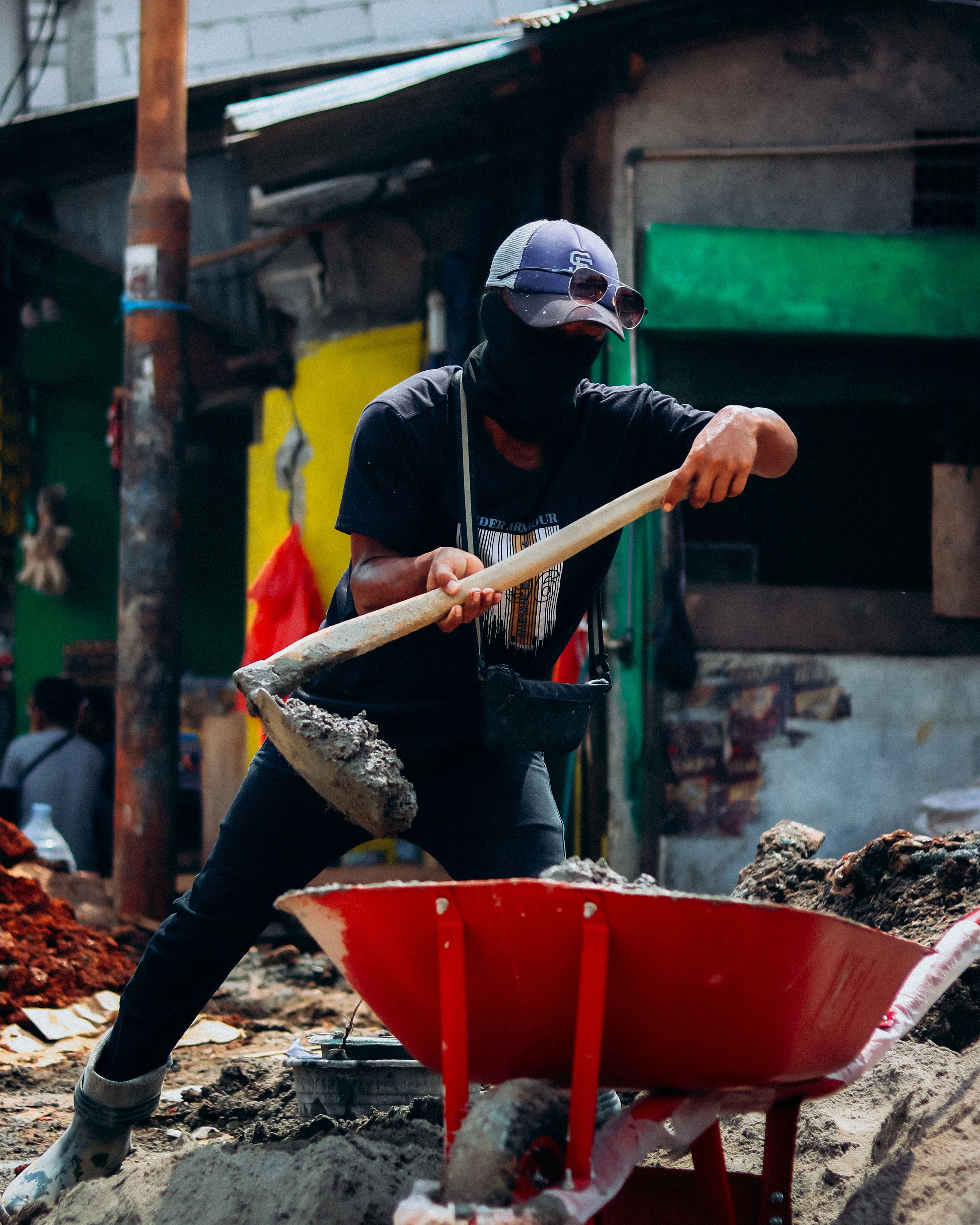 Indonesian Street Worker Shoveling Concrete · Free Stock Photo