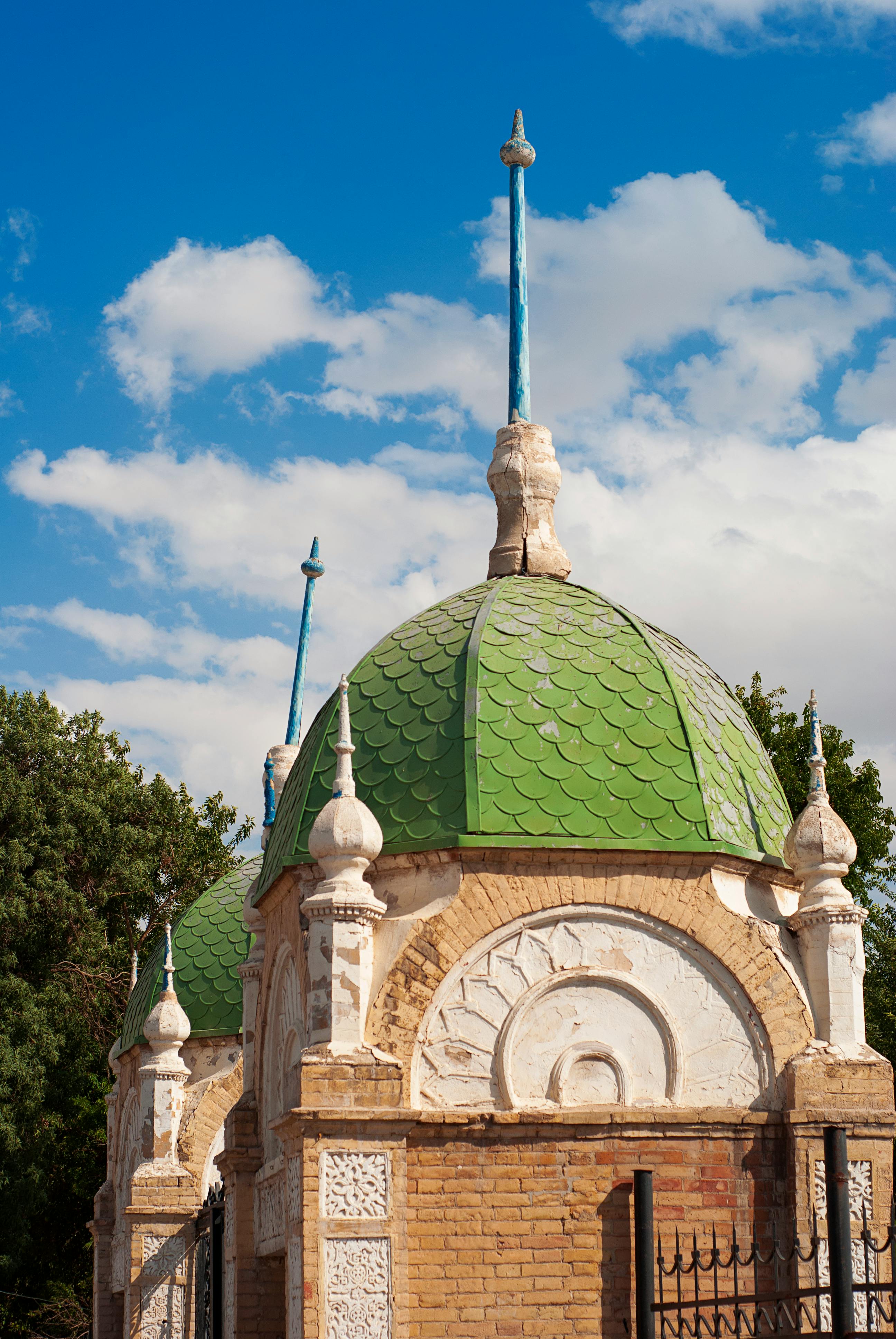 Historic Building with Green Domes Against Blue Sky · Free Stock Photo