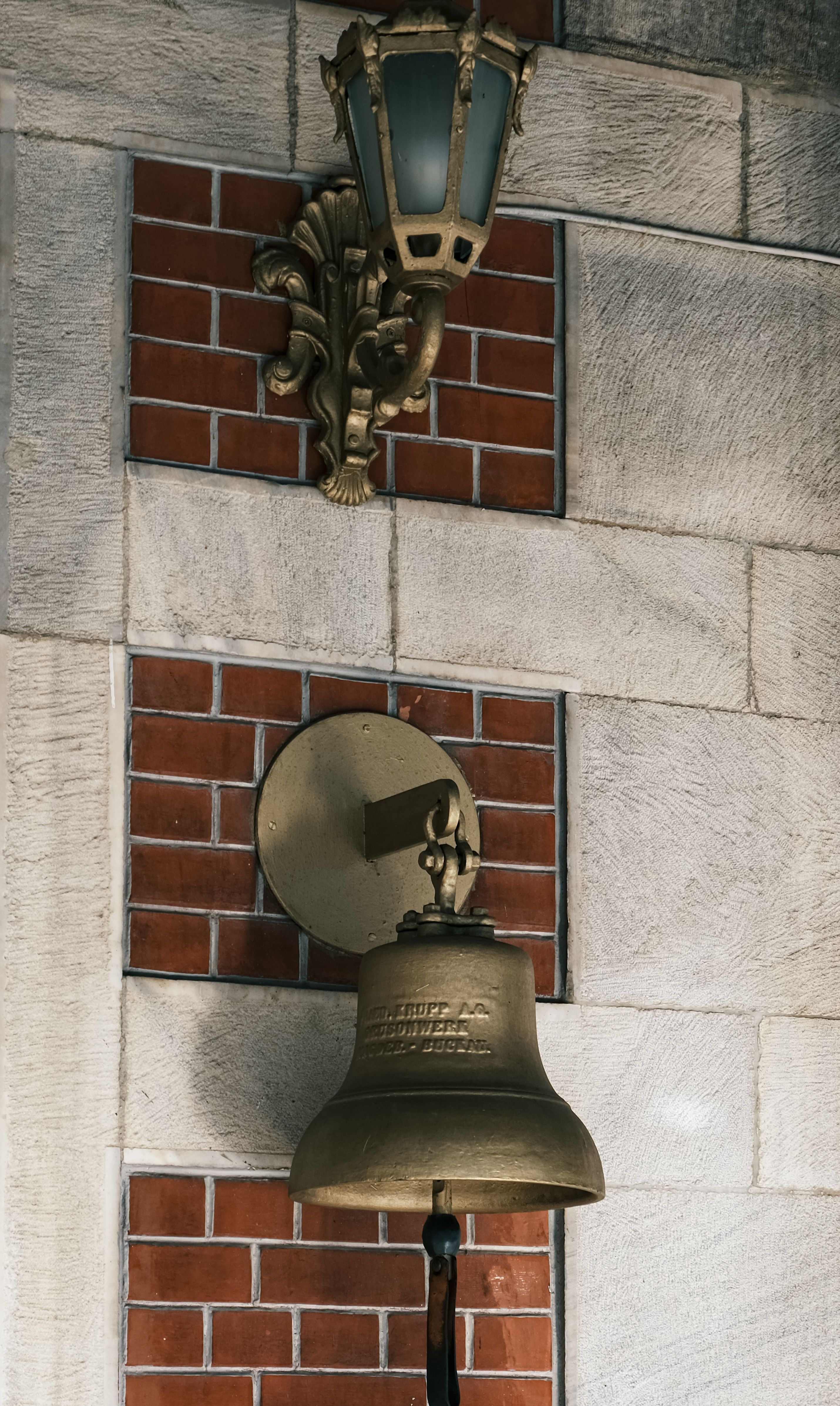 Historic Brass Bell on Brick Wall with Lamp · Free Stock Photo