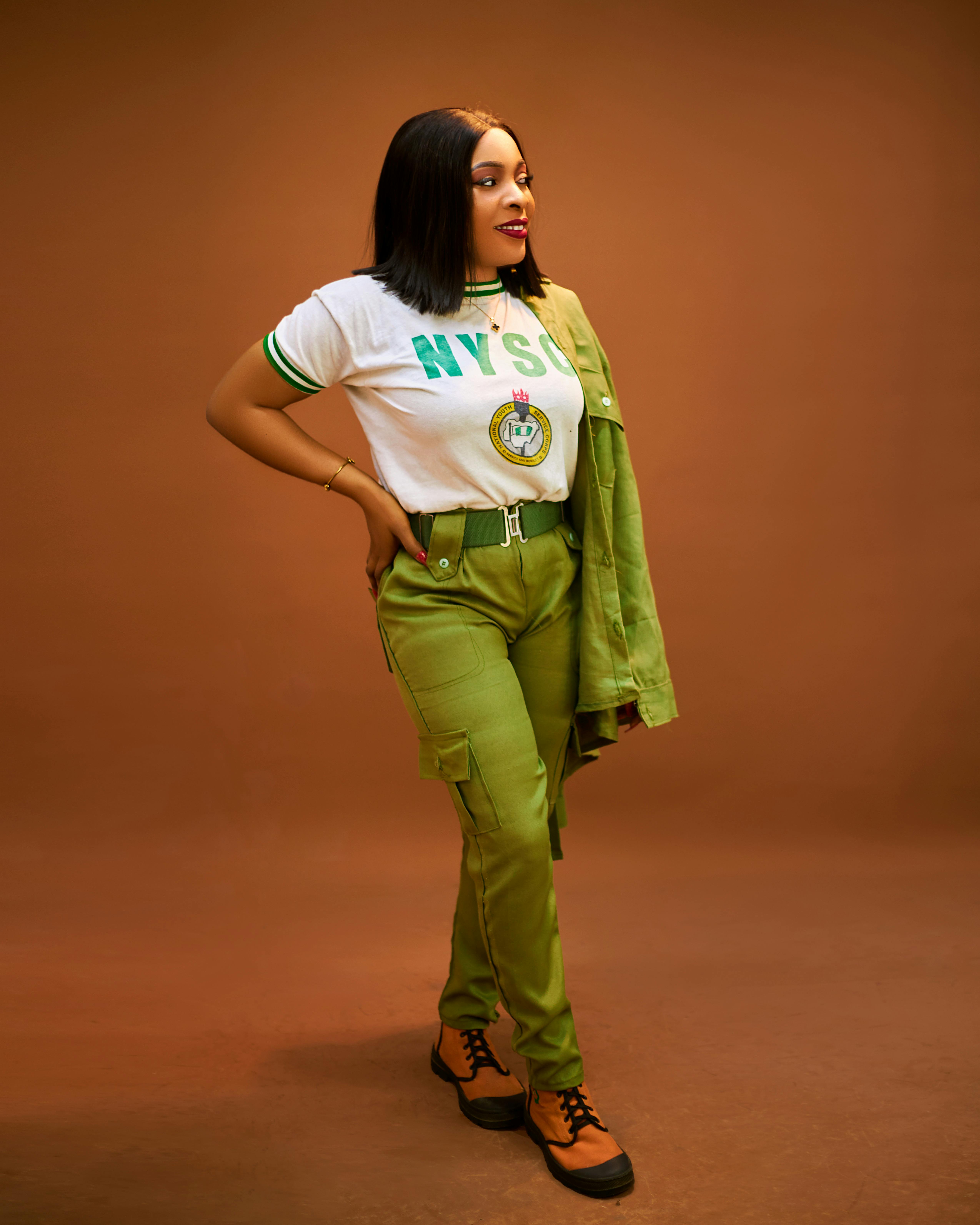 Young woman in NYSC uniform posing confidently · Free Stock Photo