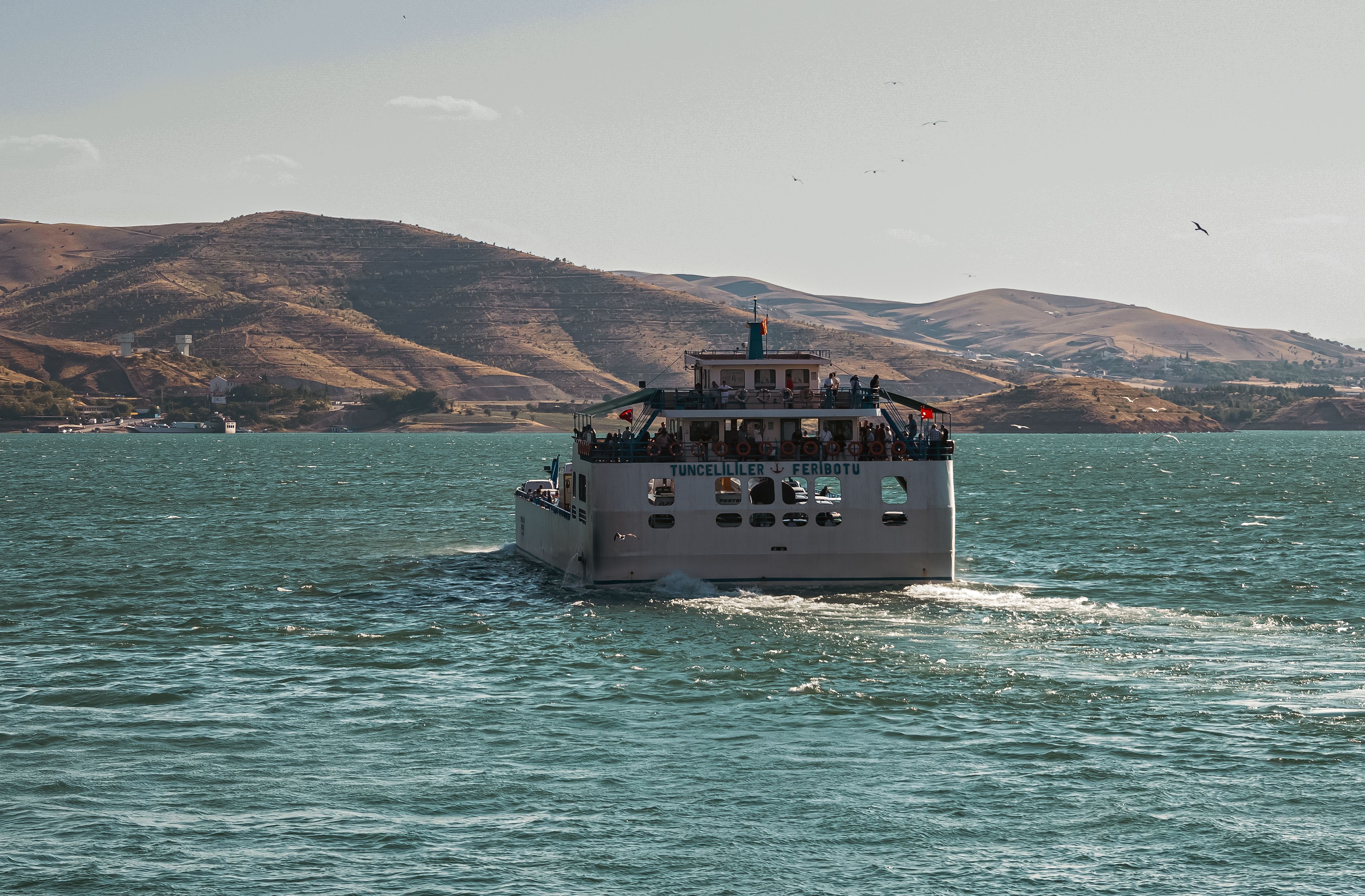 Ferry Crossing Wide Scenic Lake with Hills · Free Stock Photo