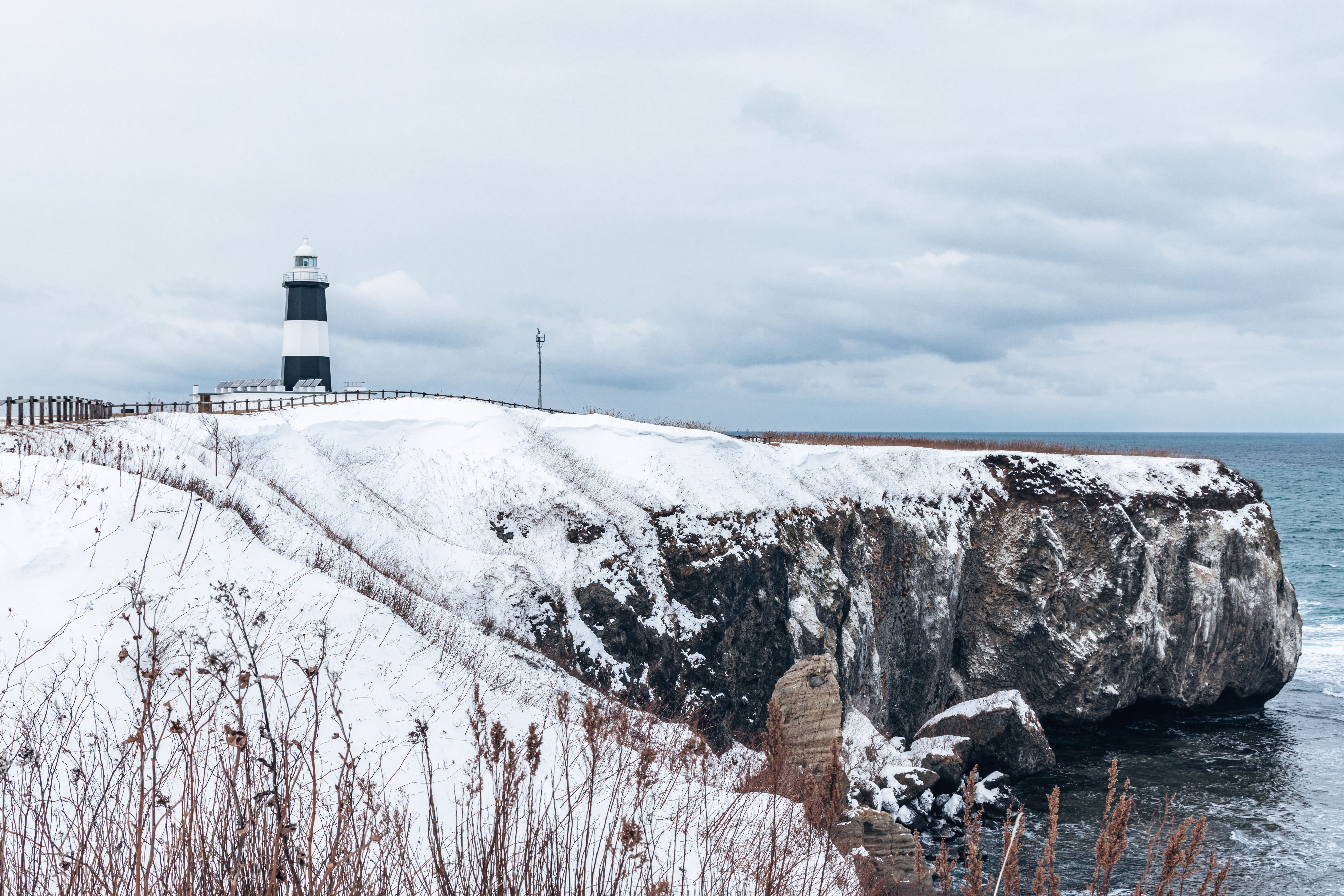 Winter Lighthouse on Snowy Cliffs in Hokkaido · Free Stock Photo