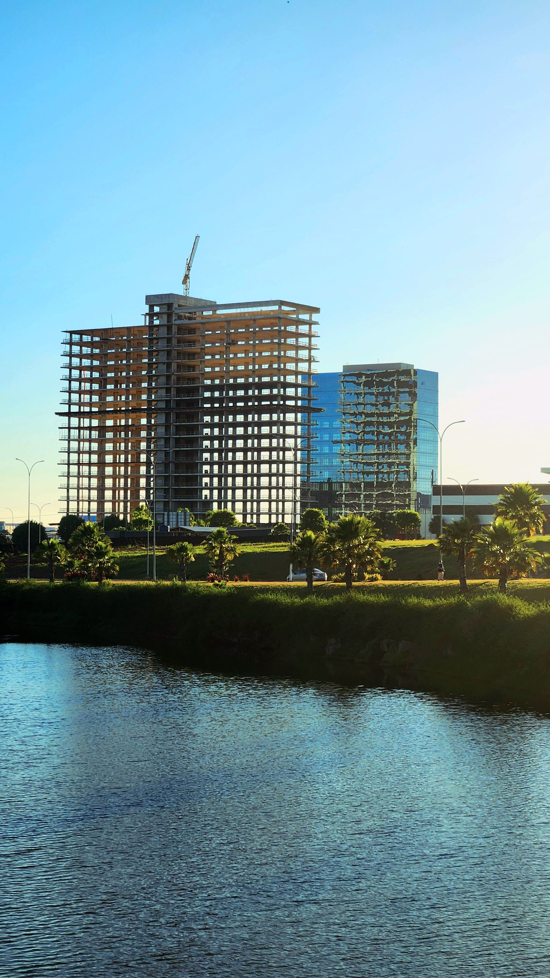 Modern Skyscrapers Under Construction by Riverside · Free Stock Photo