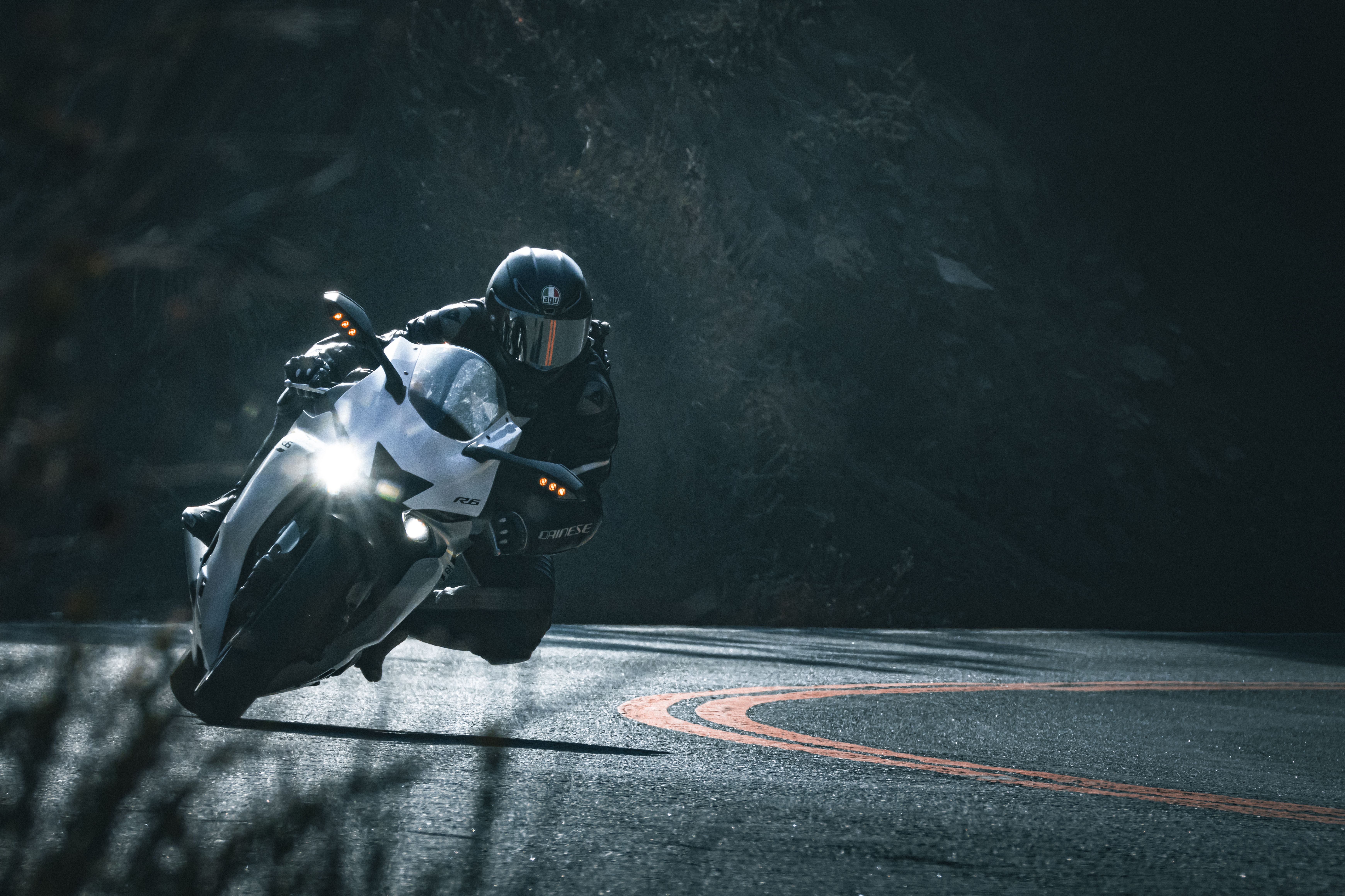 Dynamic Motorcycle Rider on Winding Road · Free Stock Photo