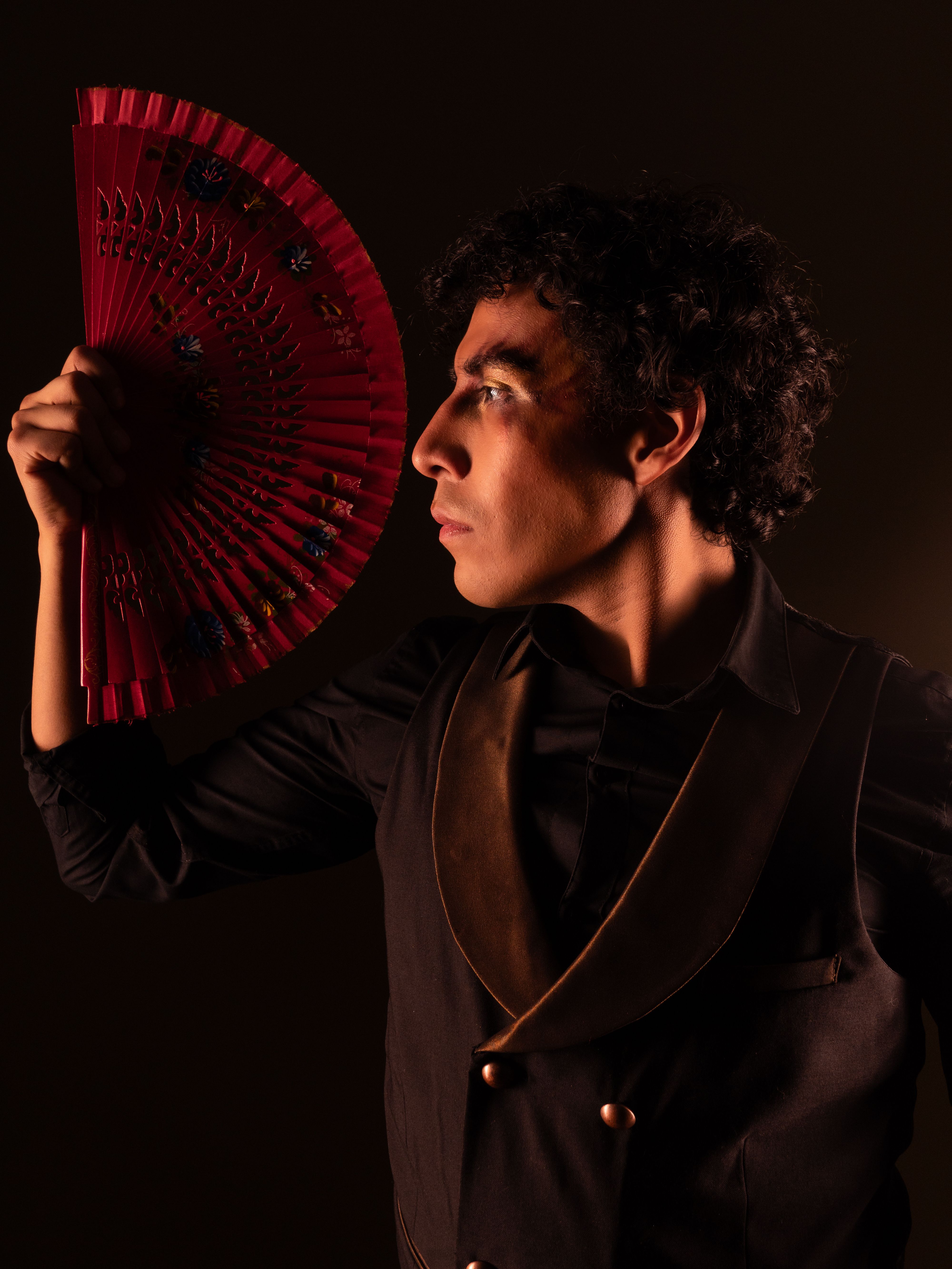 Artistic Male Dancer with Red Fan in Dramatic Lighting · Free Stock Photo