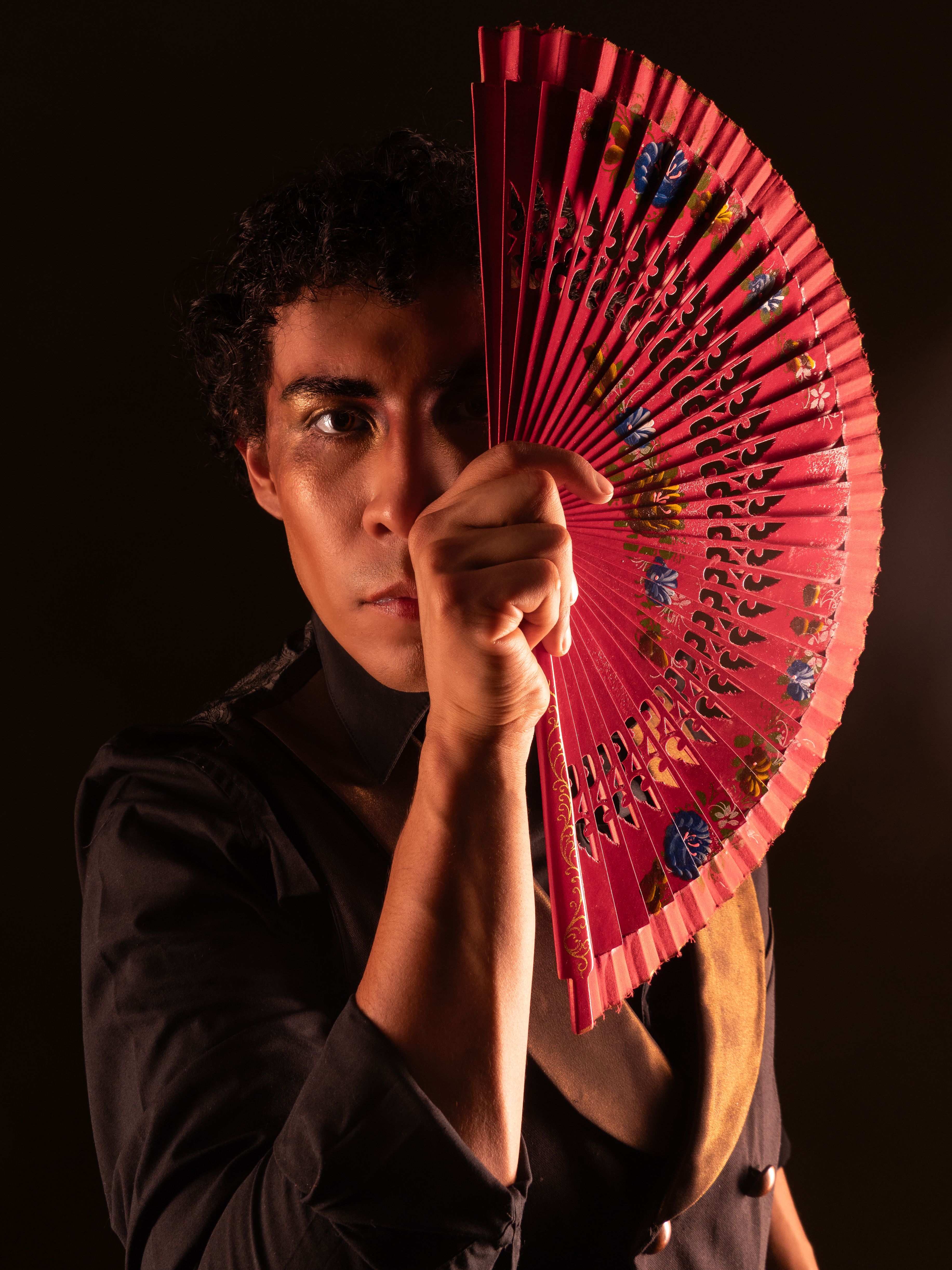 Dramatic Portrait of a Male Dancer with Fan · Free Stock Photo