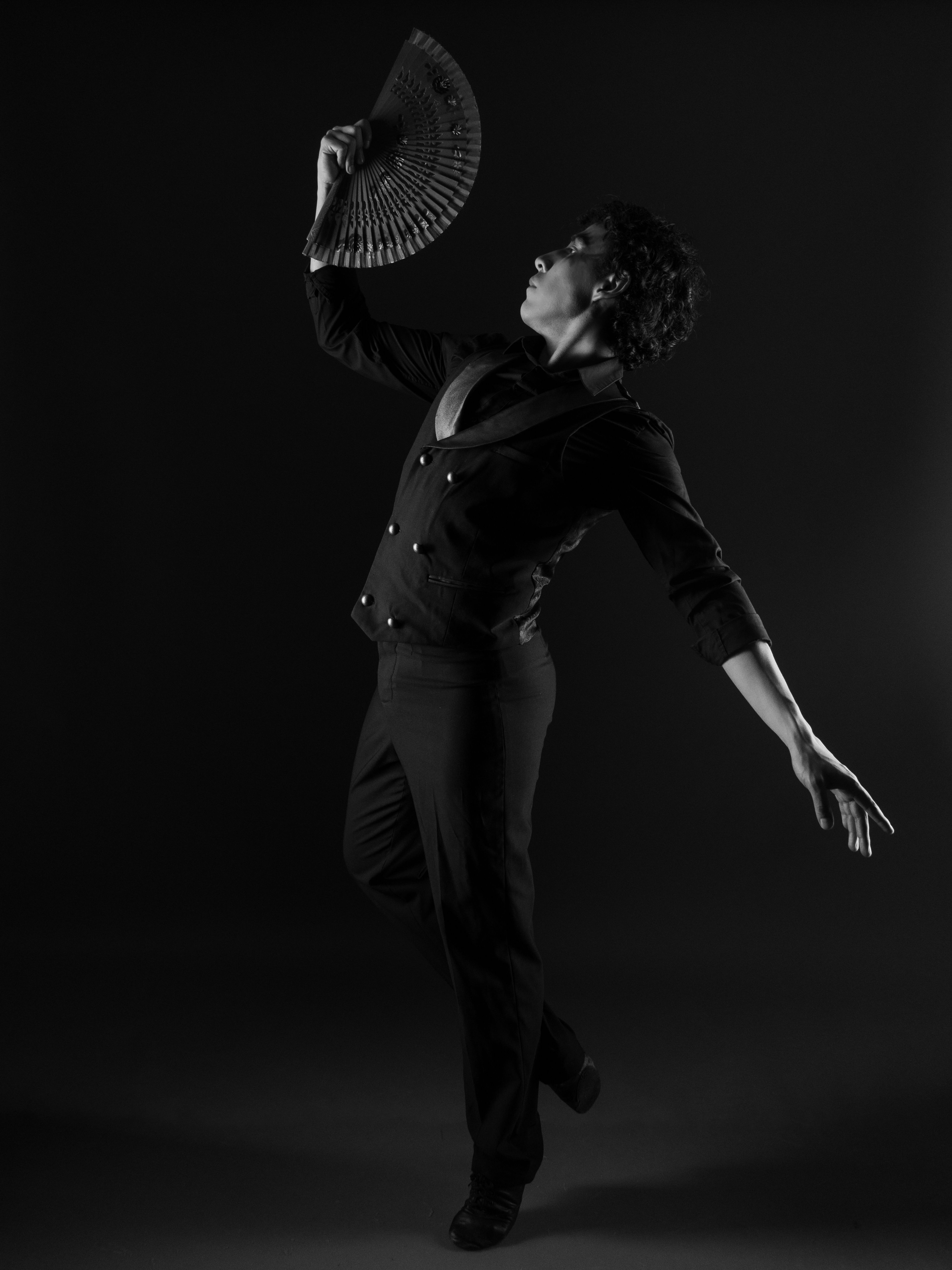 Elegant Male Dancer Posing with Fan in Black and White · Free Stock Photo