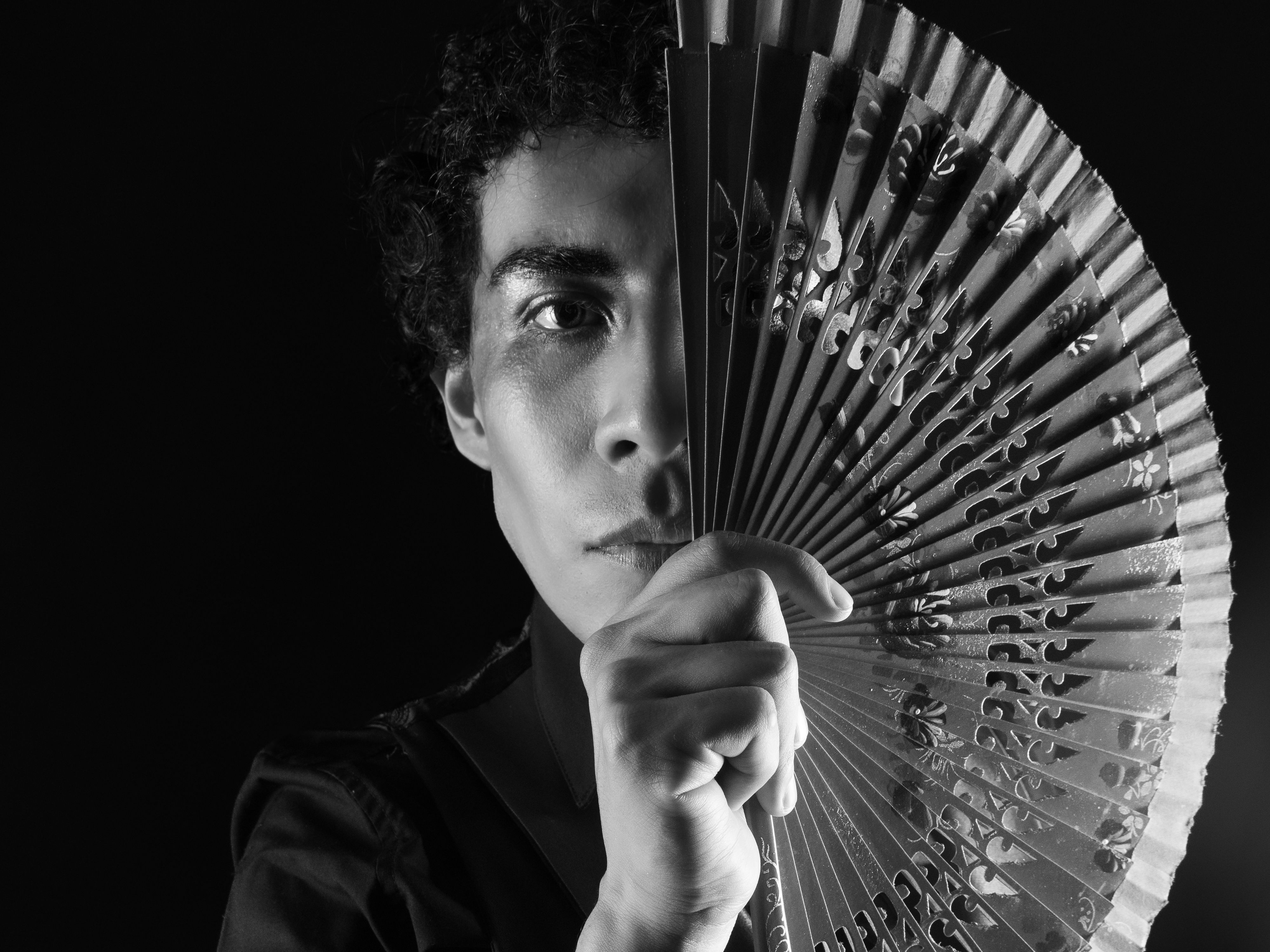 Black and White Portrait of Male Dancer with Fan · Free Stock Photo