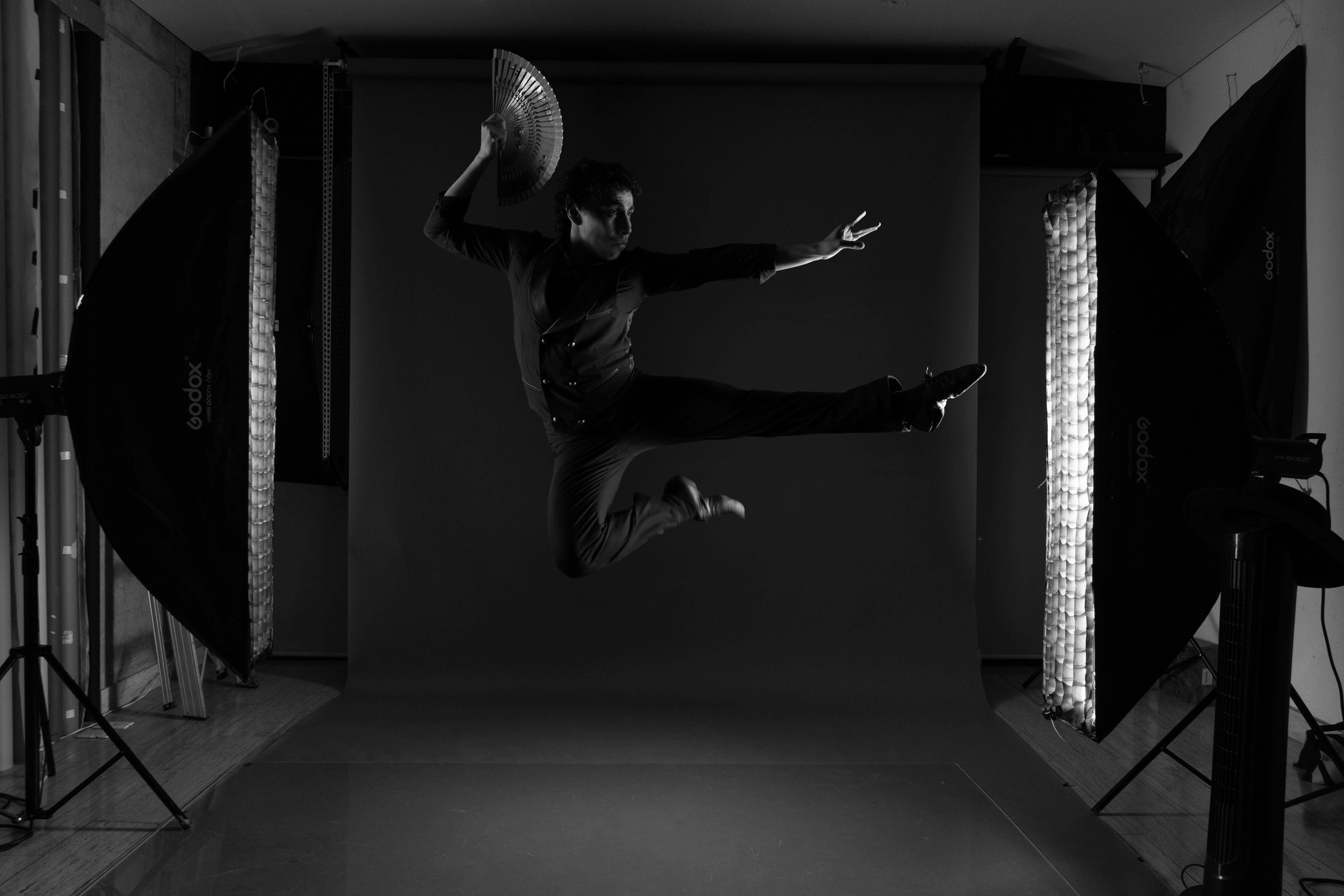 Dynamic Male Dancer in Studio Jumping Pose · Free Stock Photo