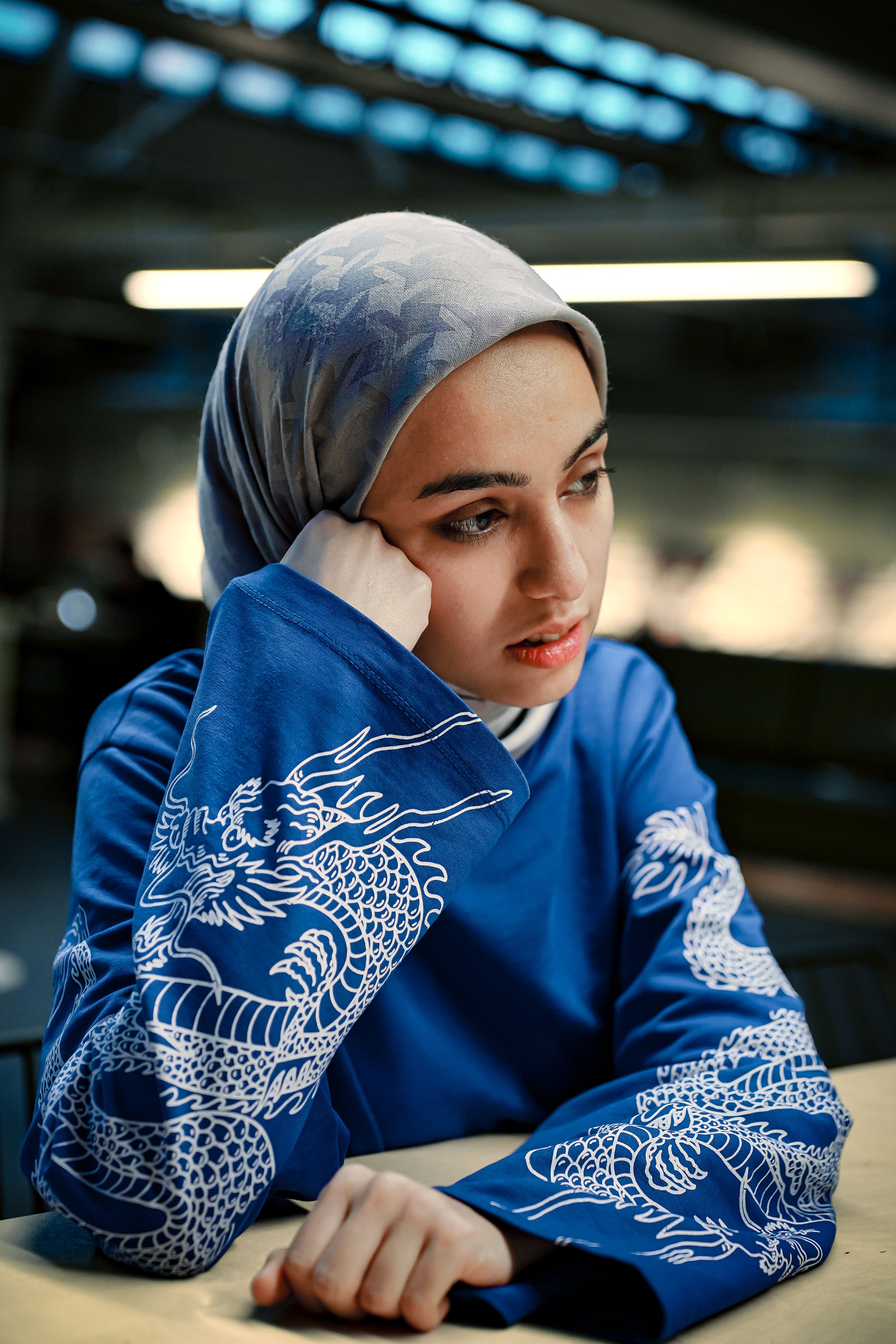Pensive Young Adult with Blue Dragon Attire · Free Stock Photo