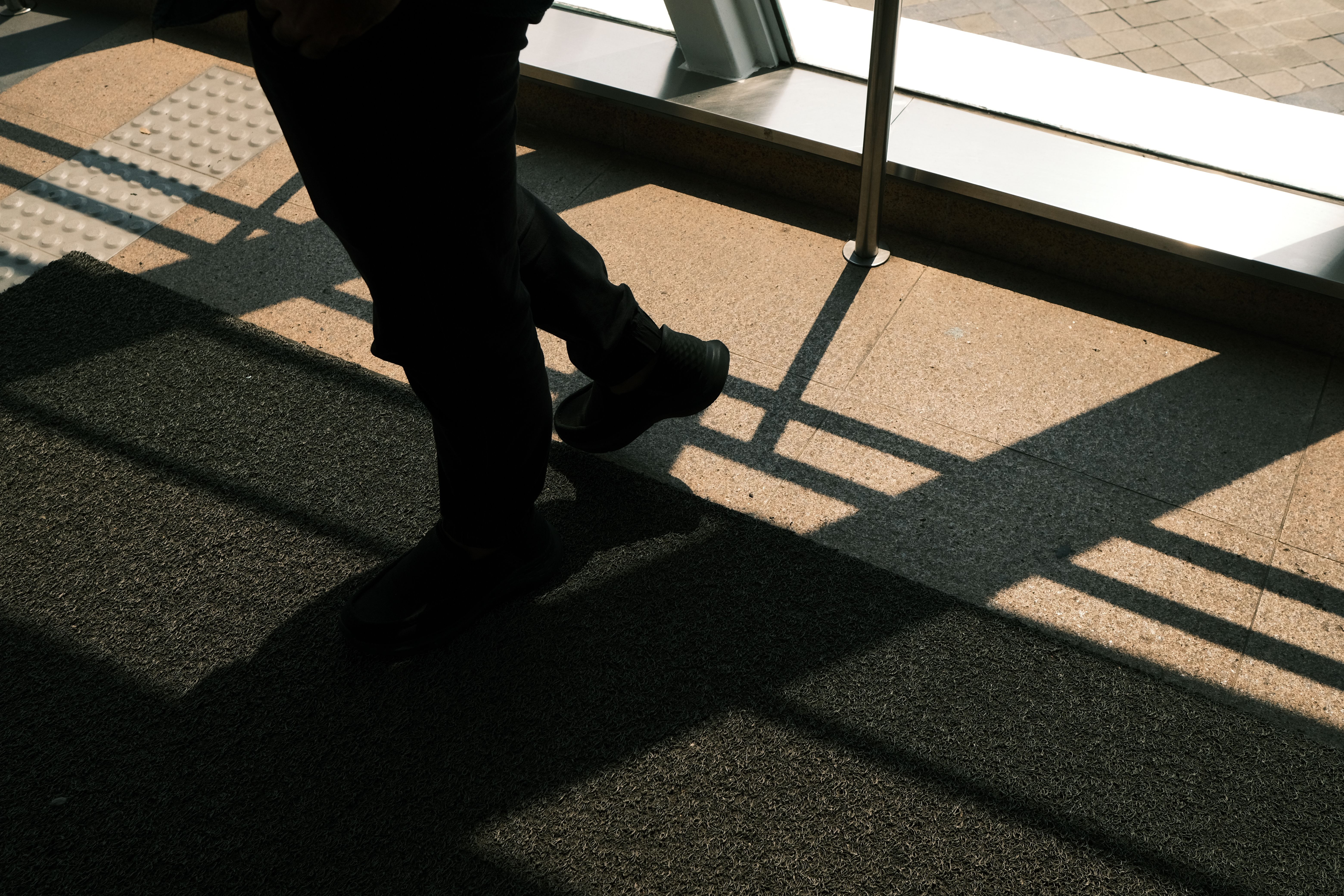 Silhouette of Person Walking Indoors in Jakarta · Free Stock Photo