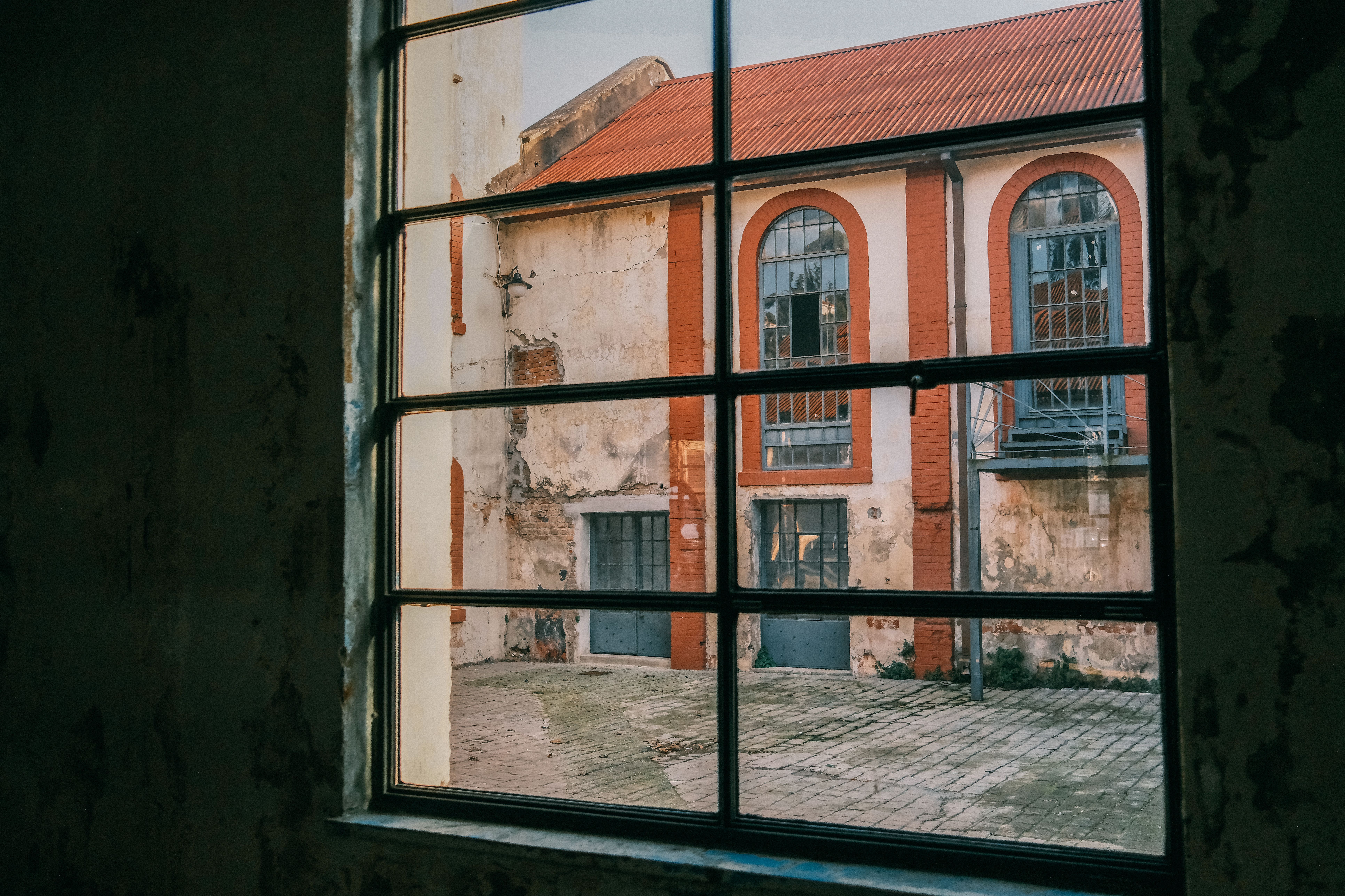Historic Red Brick Building Seen Through Window · Free Stock Photo