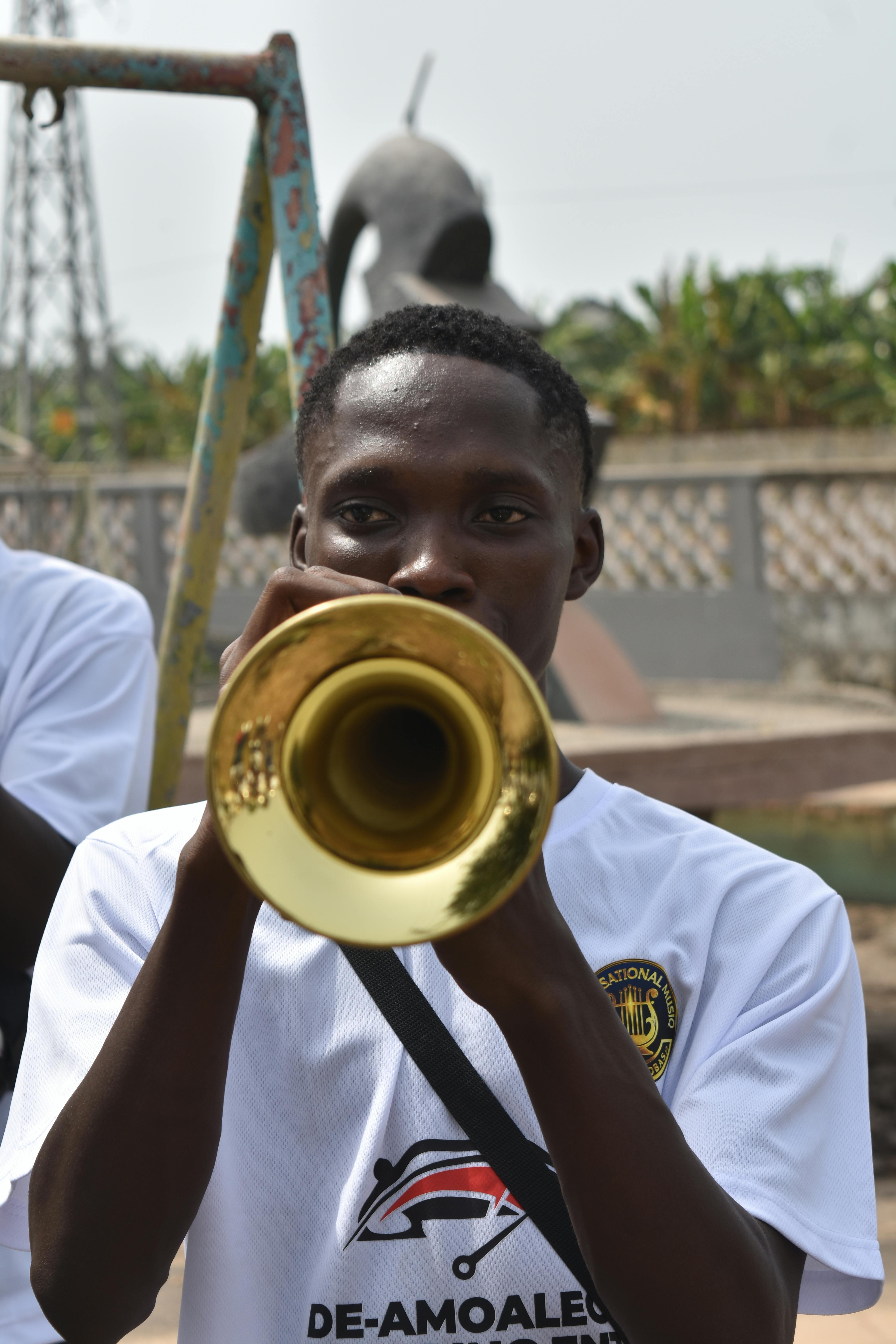 Young Musician Playing Brass Instrument Outdoors · Free Stock Photo