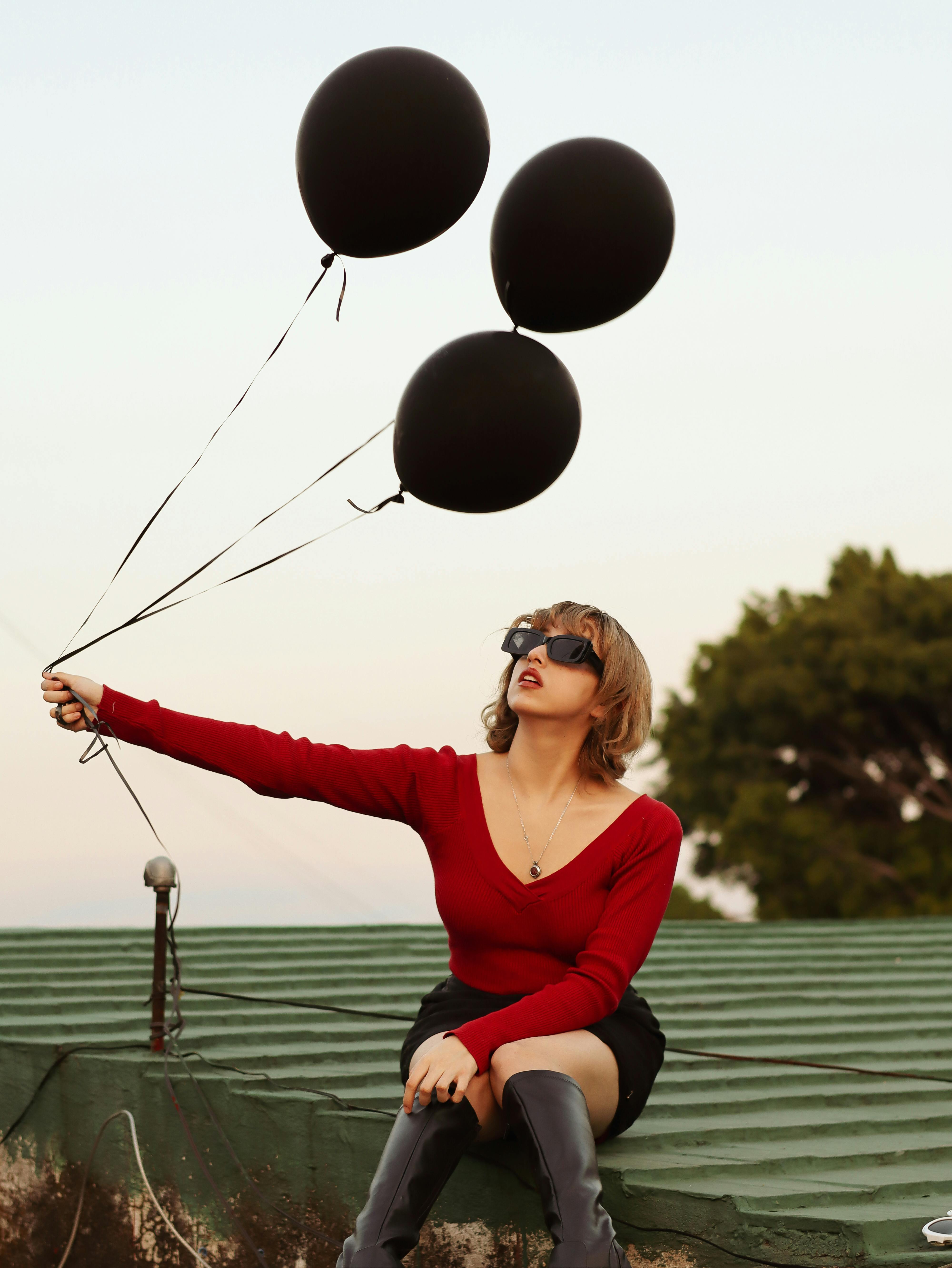 Woman with Black Balloons on Rooftop · Free Stock Photo