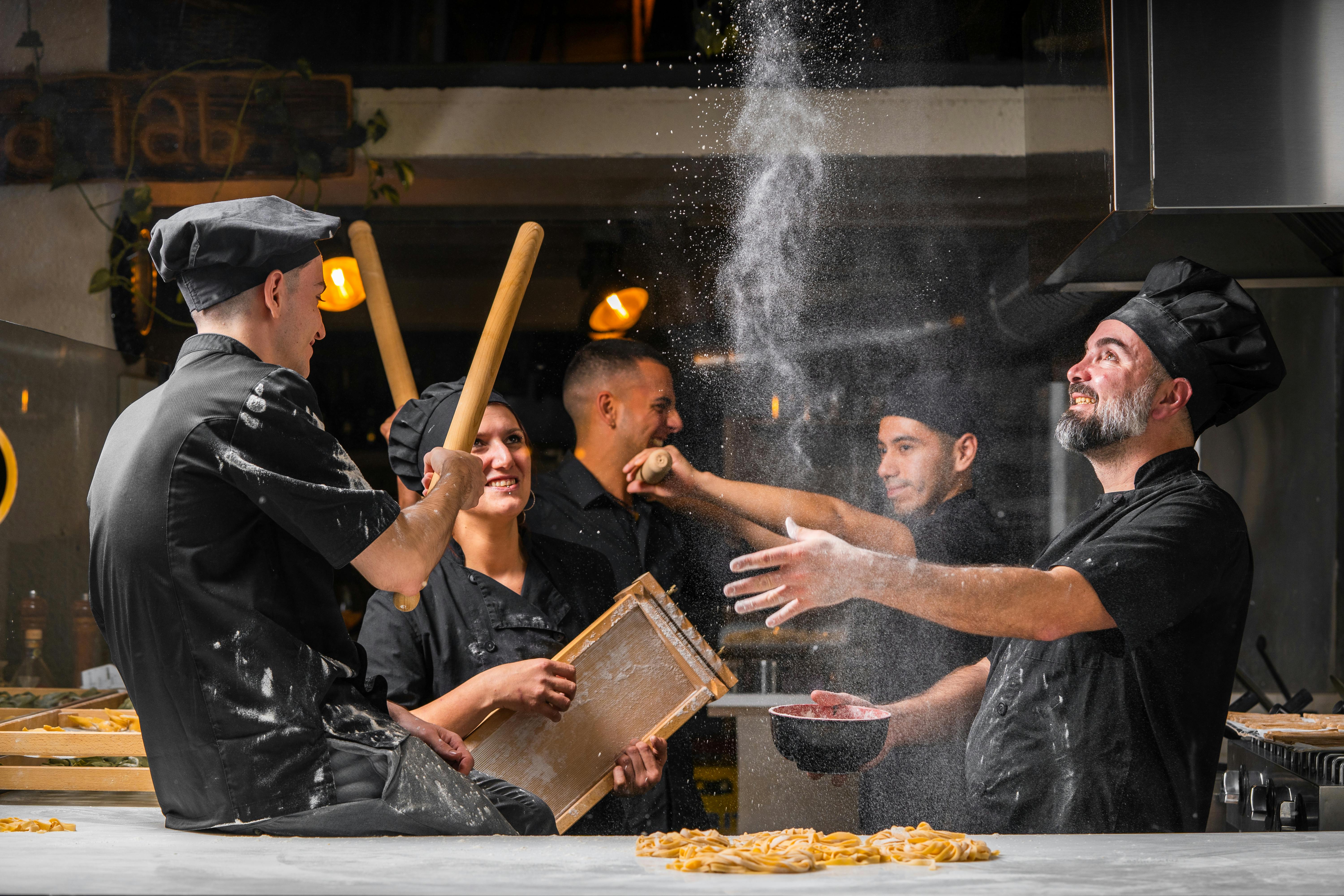 Chefs Having Fun Making Pasta in Kitchen · Free Stock Photo