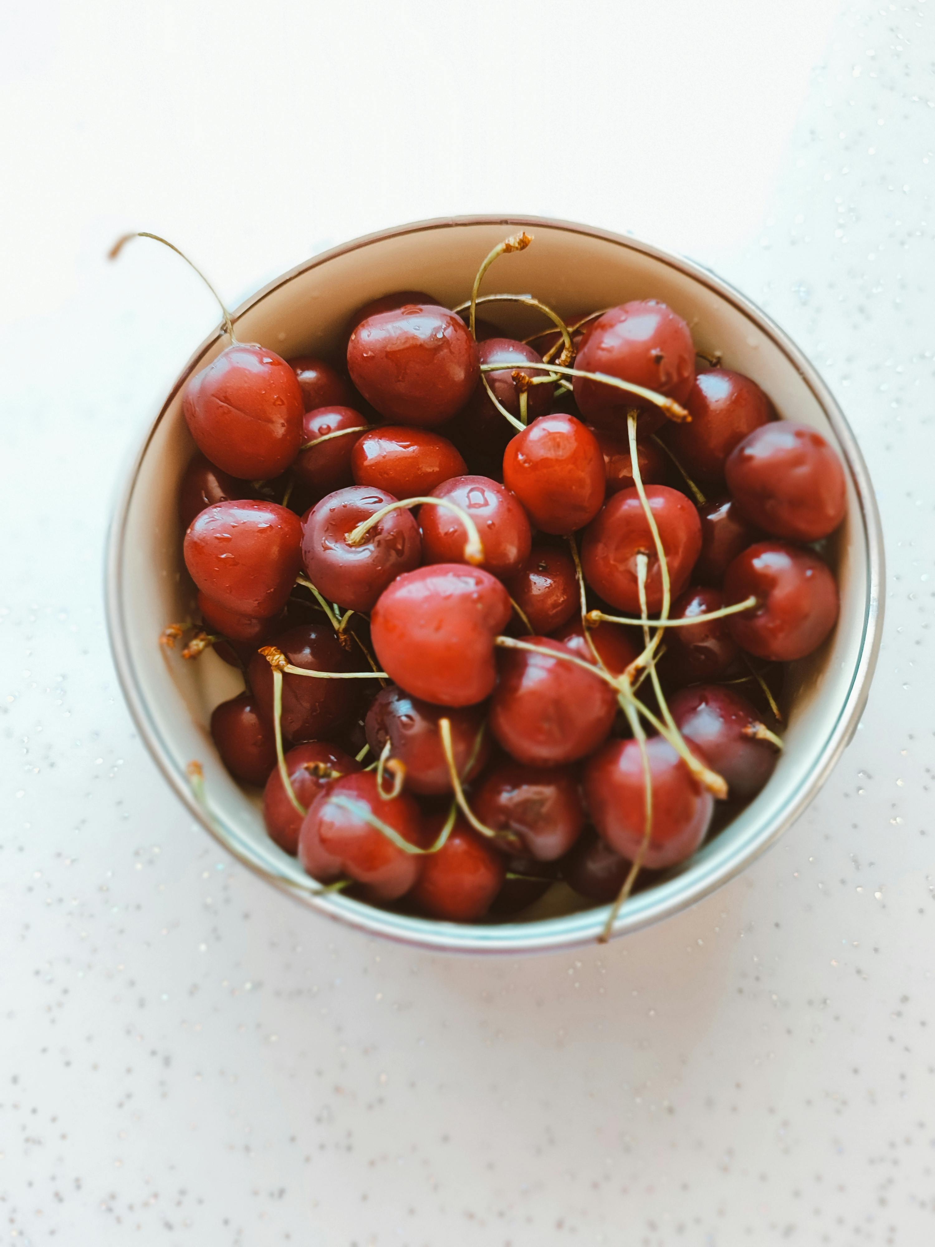 Fresh Red Cherries in a Bowl on White Table · Free Stock Photo
