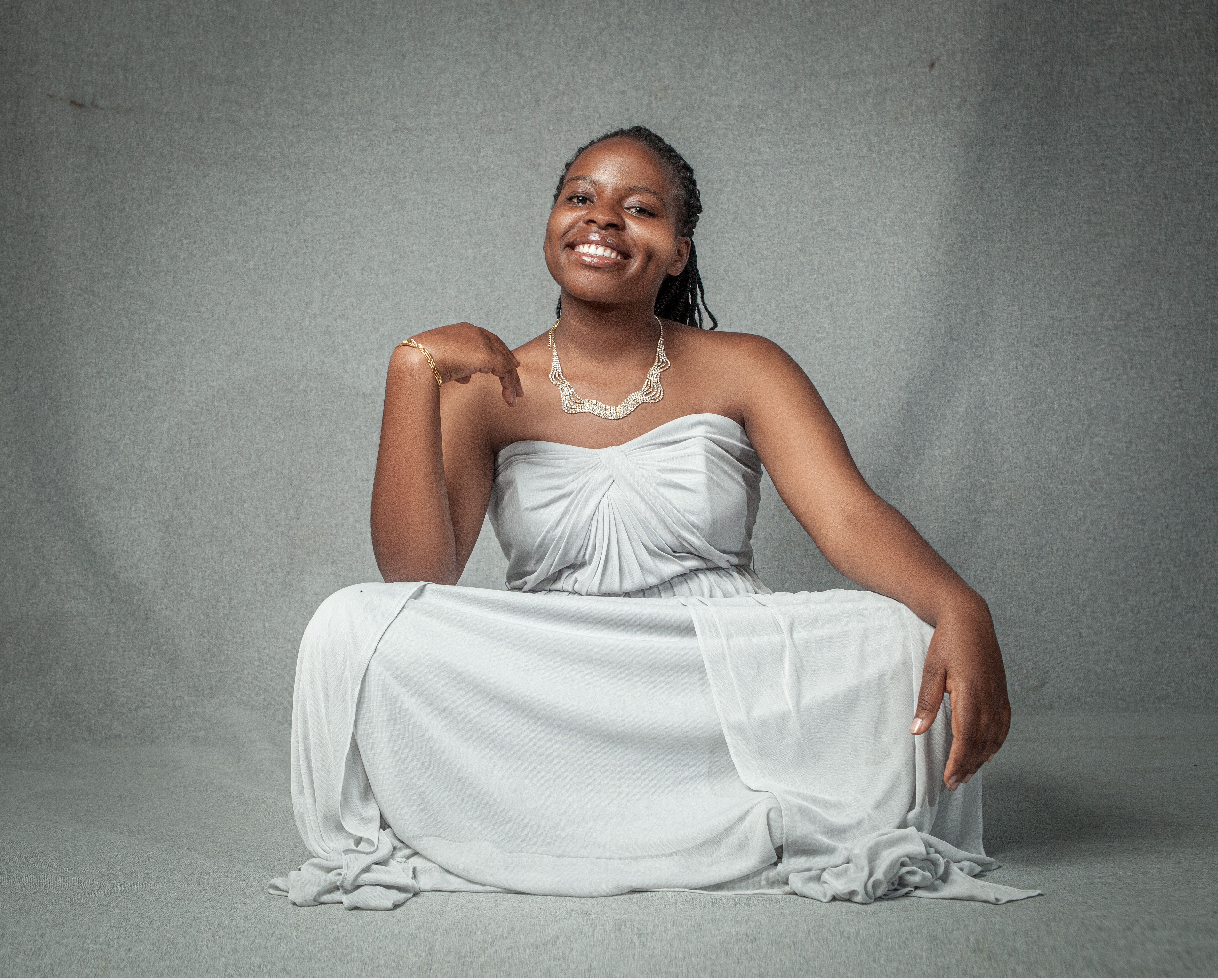 Elegant African Woman Smiling in Studio Portrait · Free Stock Photo