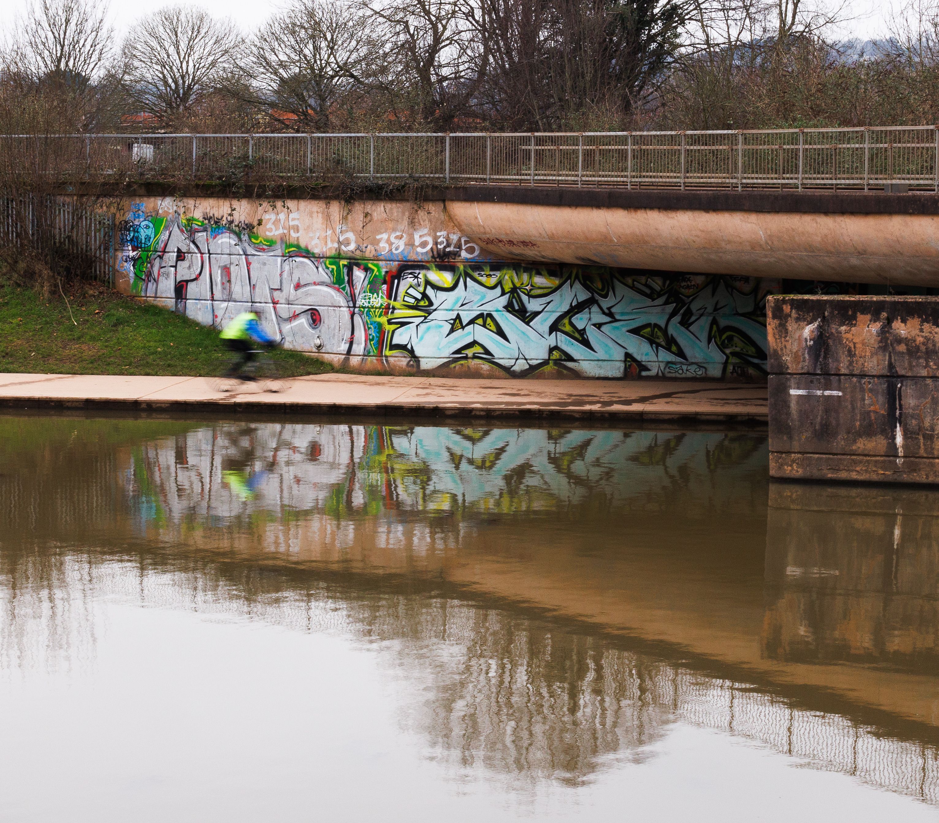 Urban Graffiti Under Bridge Reflection Scene · Free Stock Photo