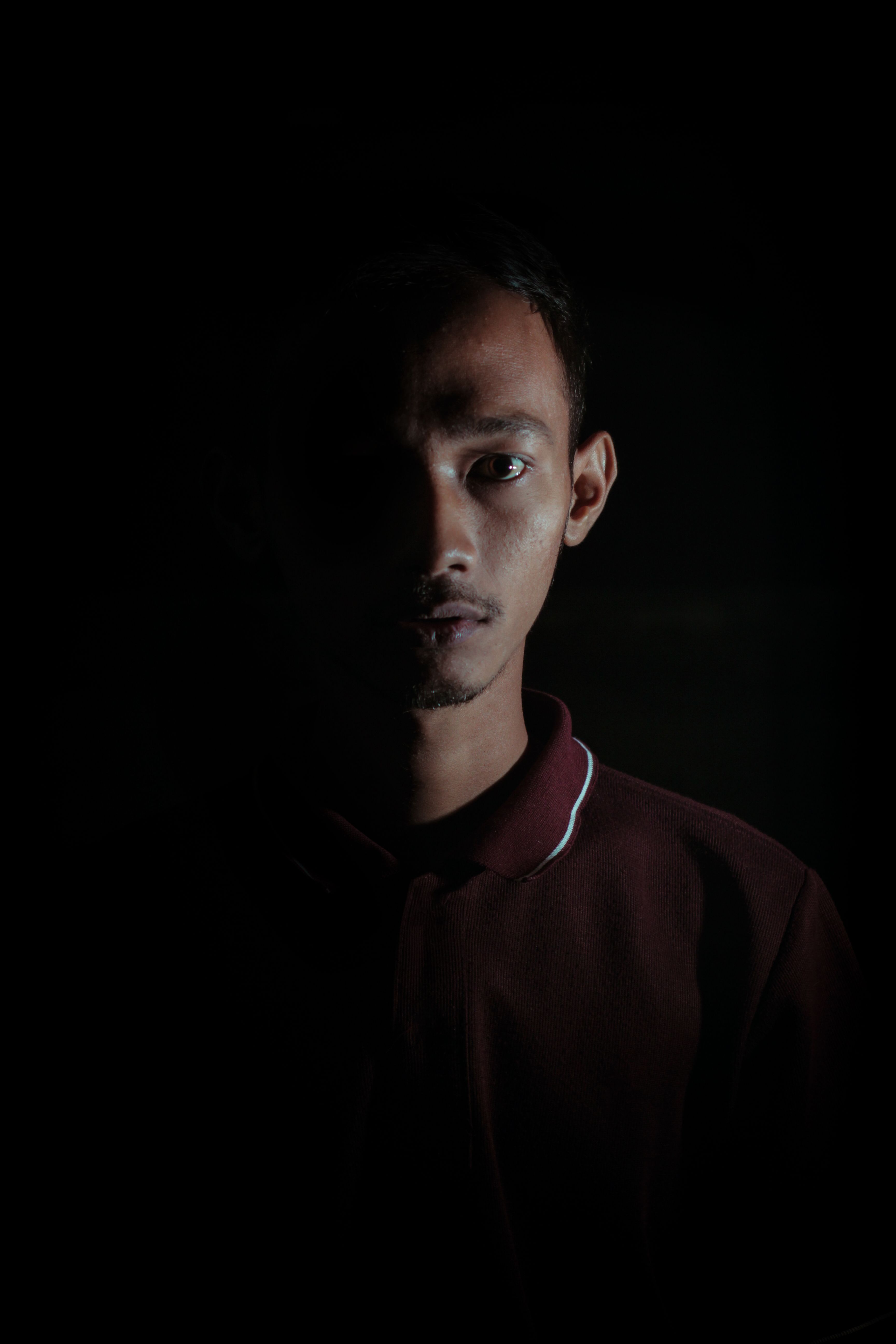 Dramatic Low-Light Portrait of a Young Man · Free Stock Photo