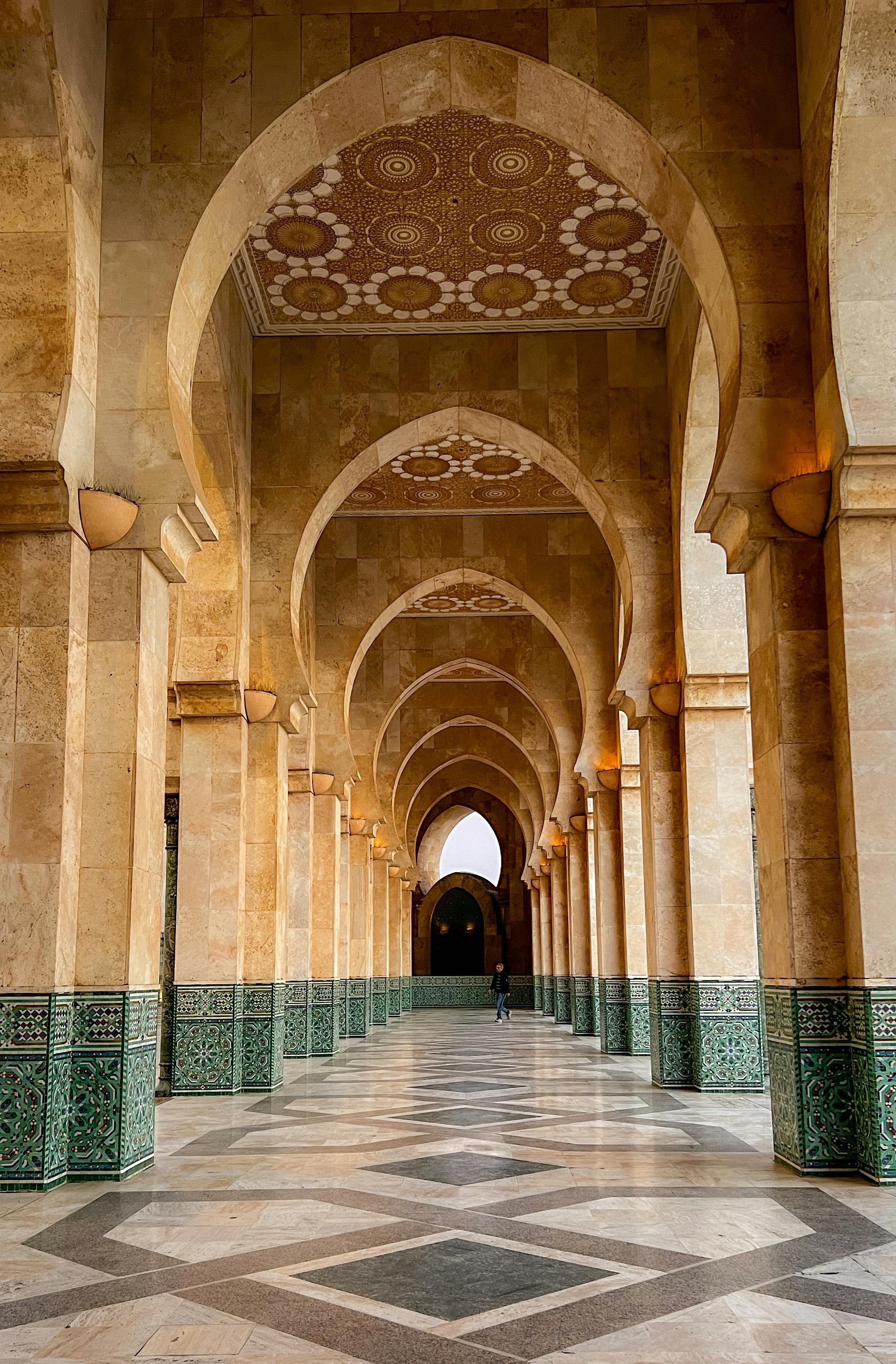 Majestic Arched Mosque Corridor with Intricate Design · Free Stock Photo