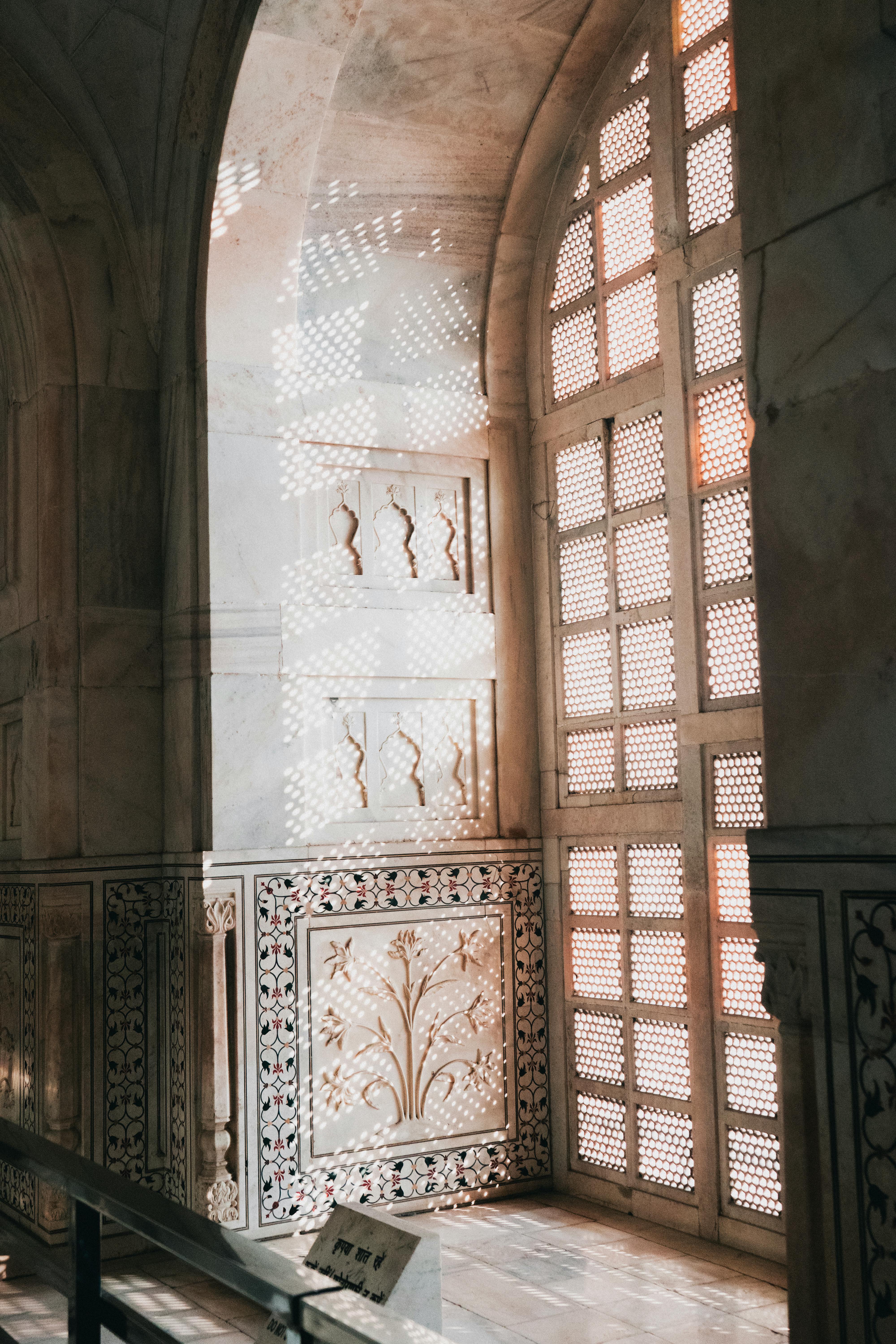 Sunlight Filters Through Ornate Architectural Window · Free Stock Photo