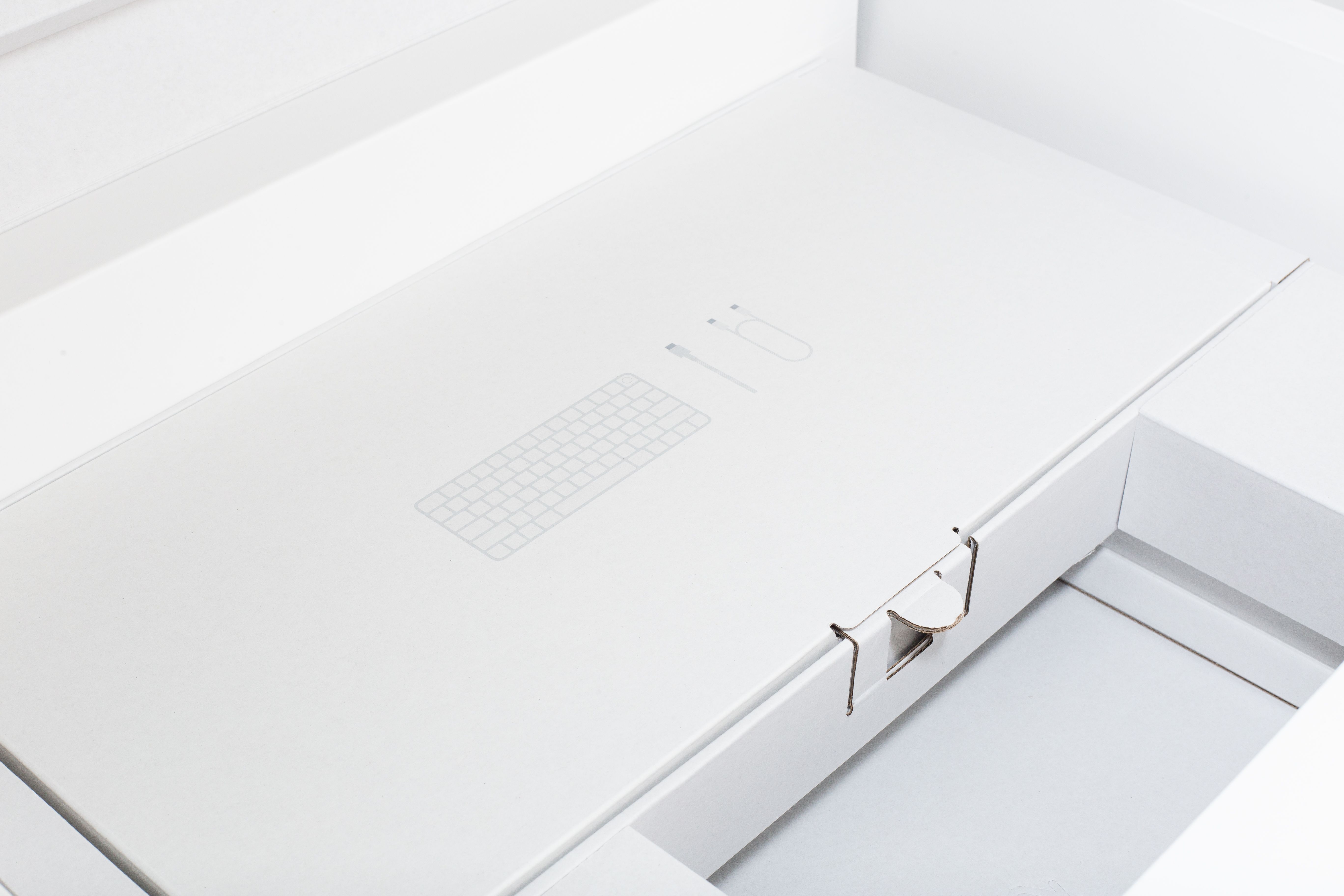 Minimalist white electronics packaging design · Free Stock Photo