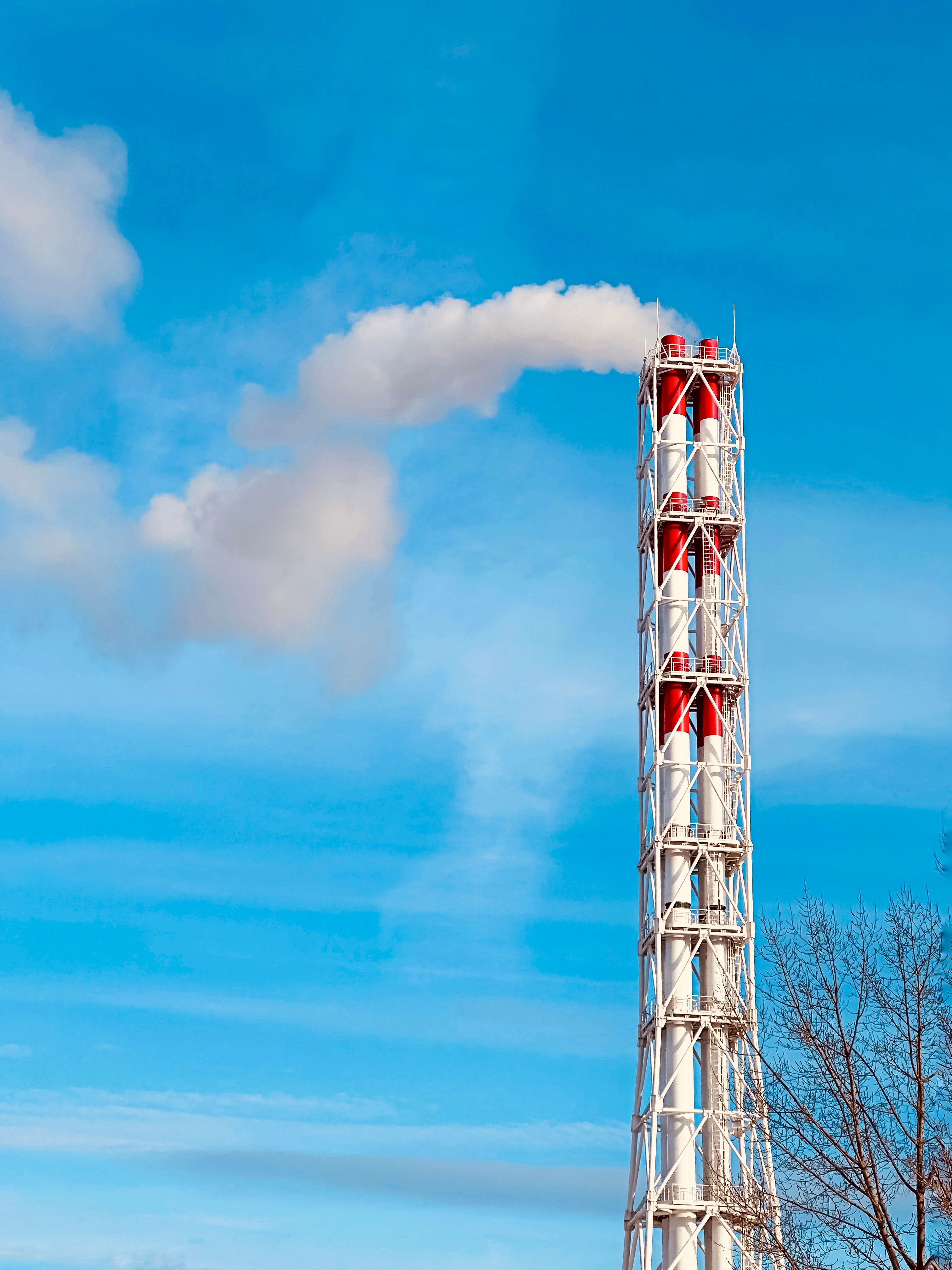 Industrial Chimney Emitting Smoke Under Blue Sky · Free Stock Photo