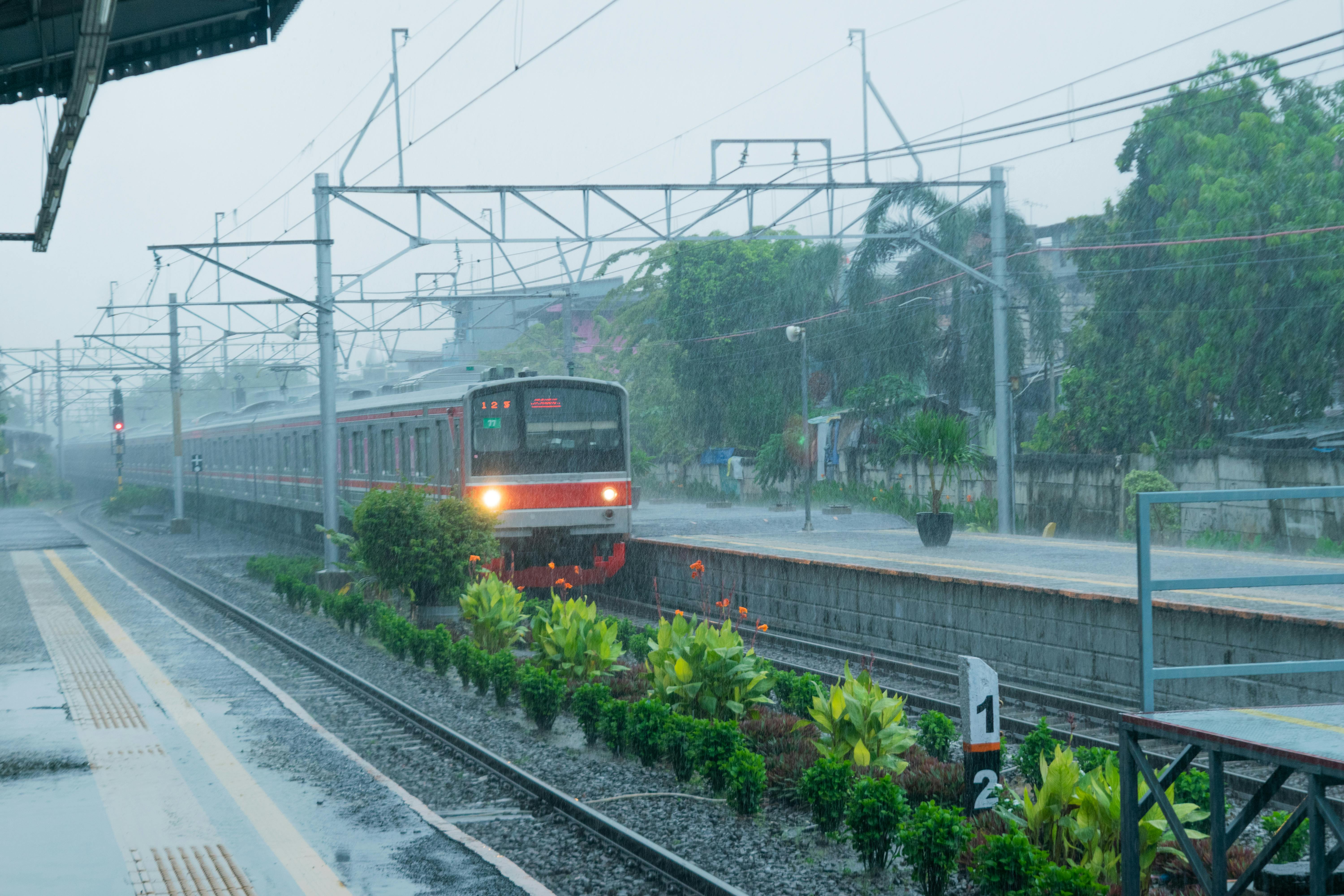 Train Approaching Platform in Heavy Rain · Free Stock Photo