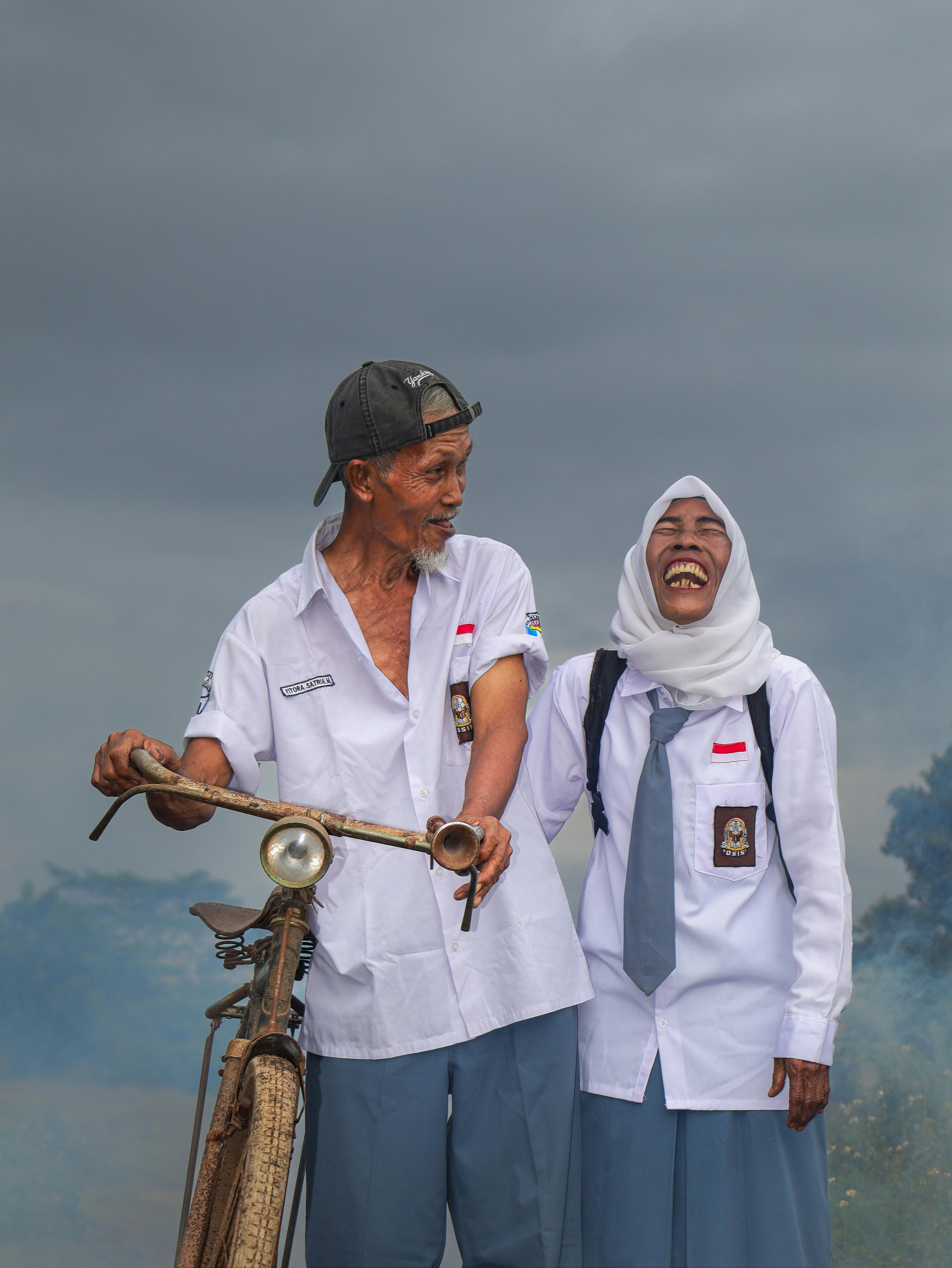Joyful Elder and Student with Bicycle Outdoors · Free Stock Photo