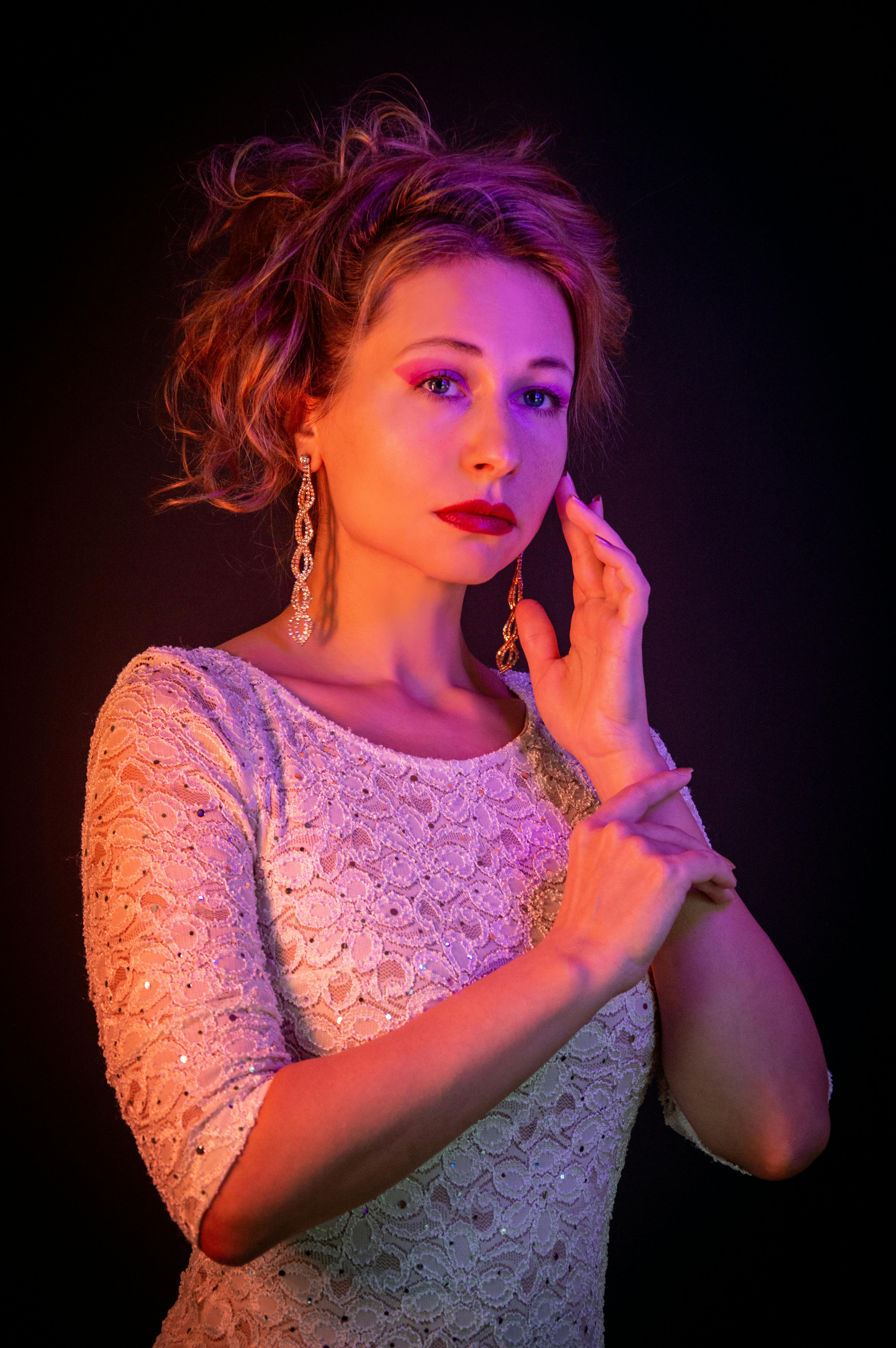 Elegant Woman in Sparkling Dress with Artistic Lighting · Free Stock Photo