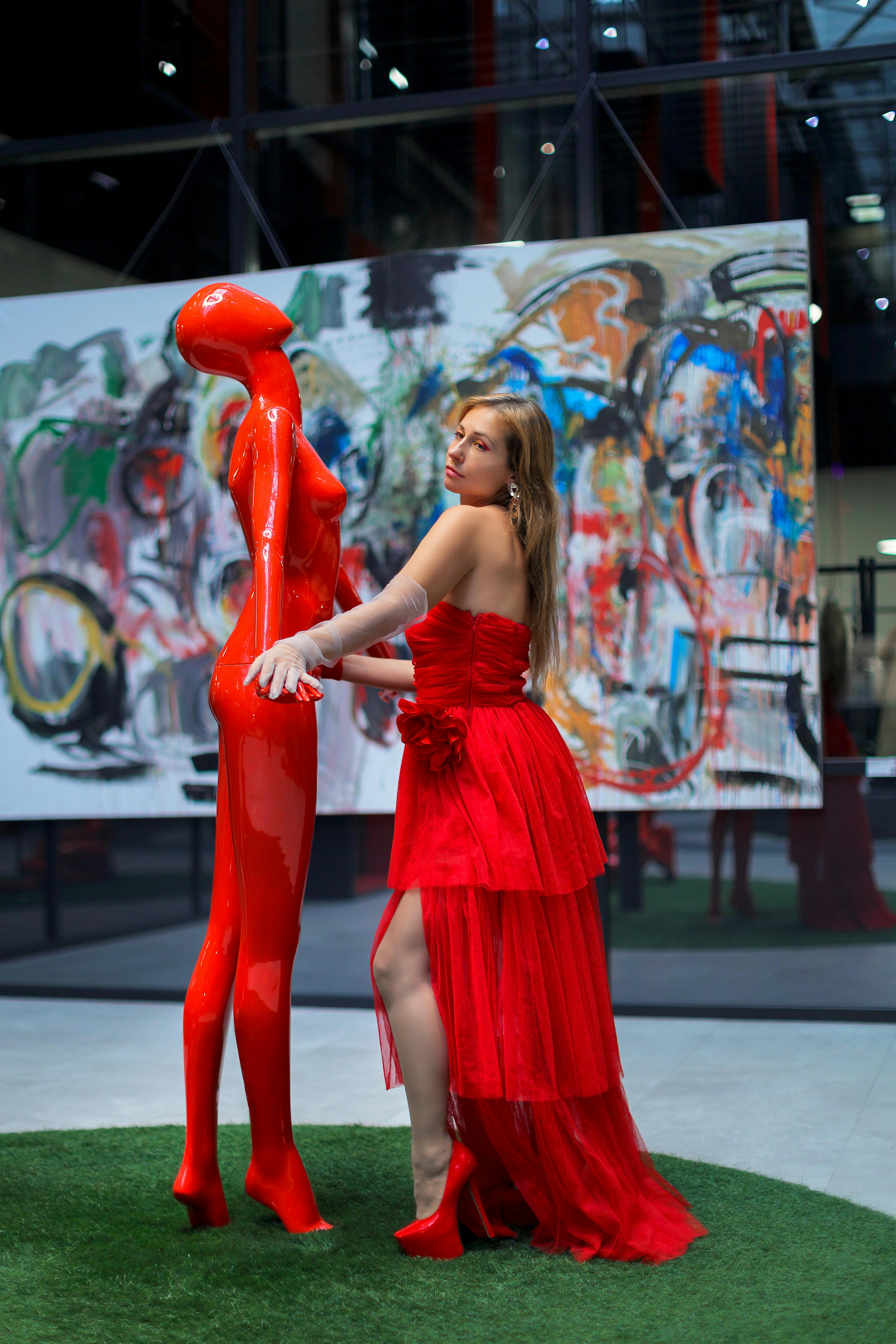 Fashionable Woman Posing with Red Mannequin · Free Stock Photo