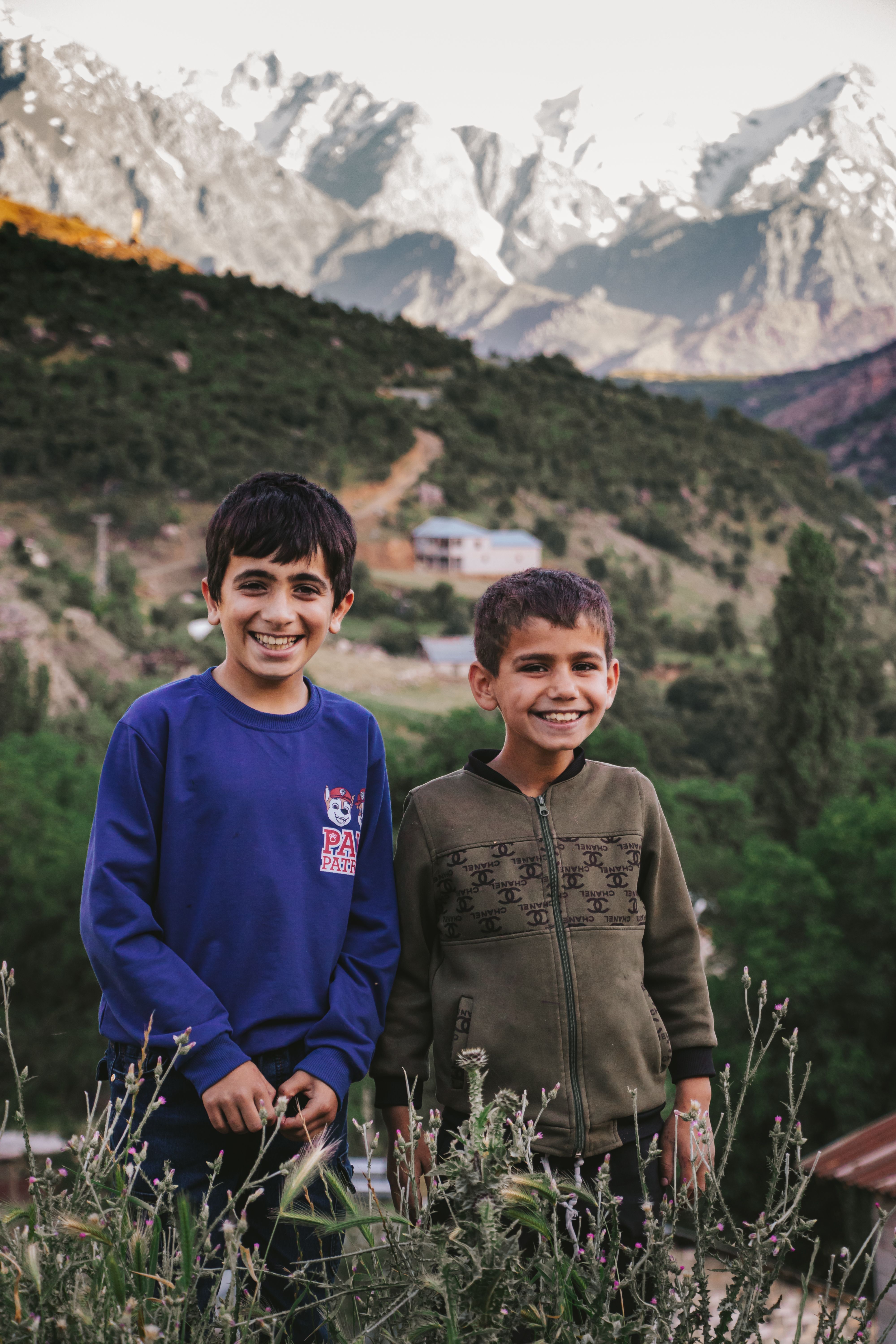 Children Smiling in Mountainous Landscape · Free Stock Photo