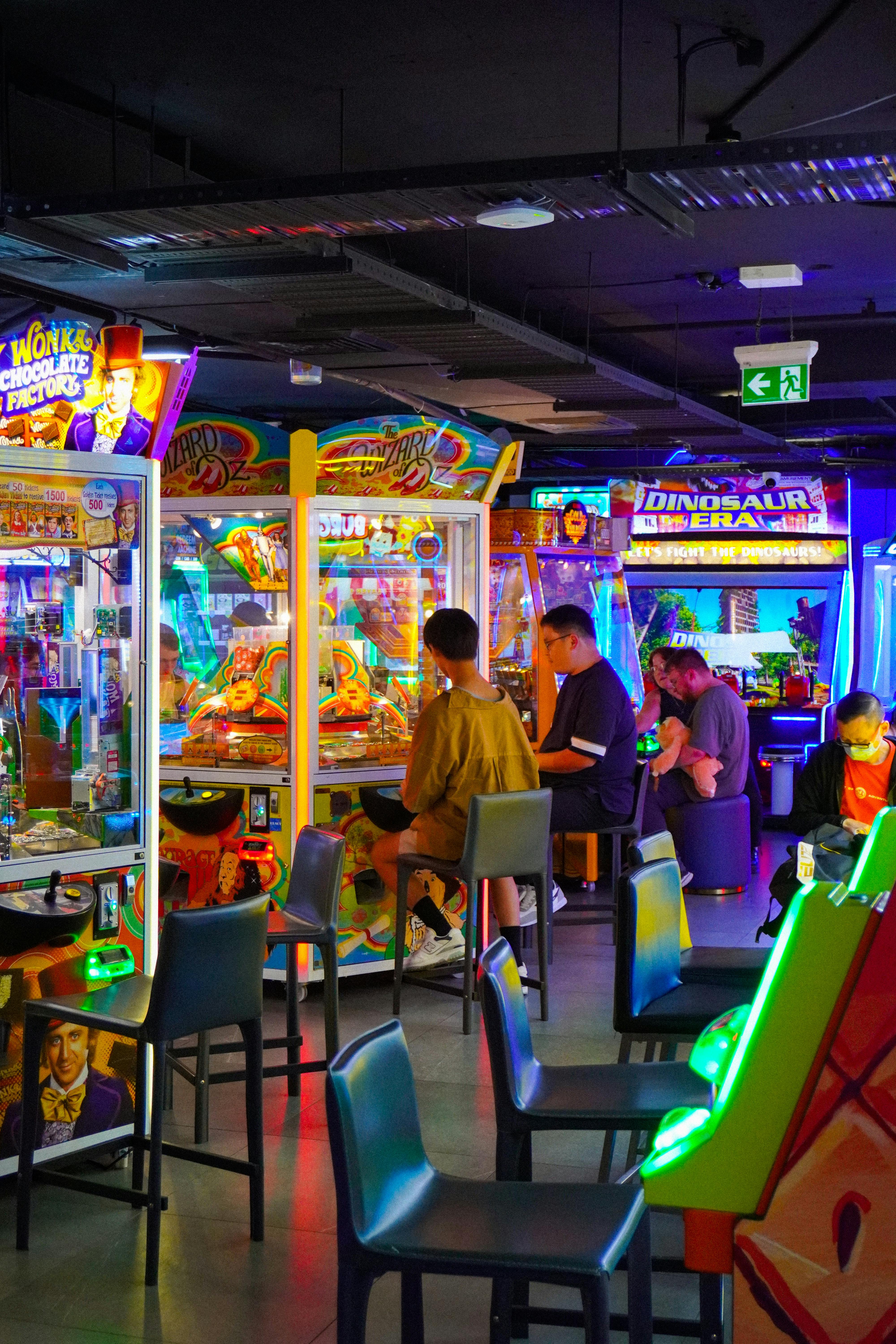 Vibrant Arcade Gaming Scene with Players · Free Stock Photo