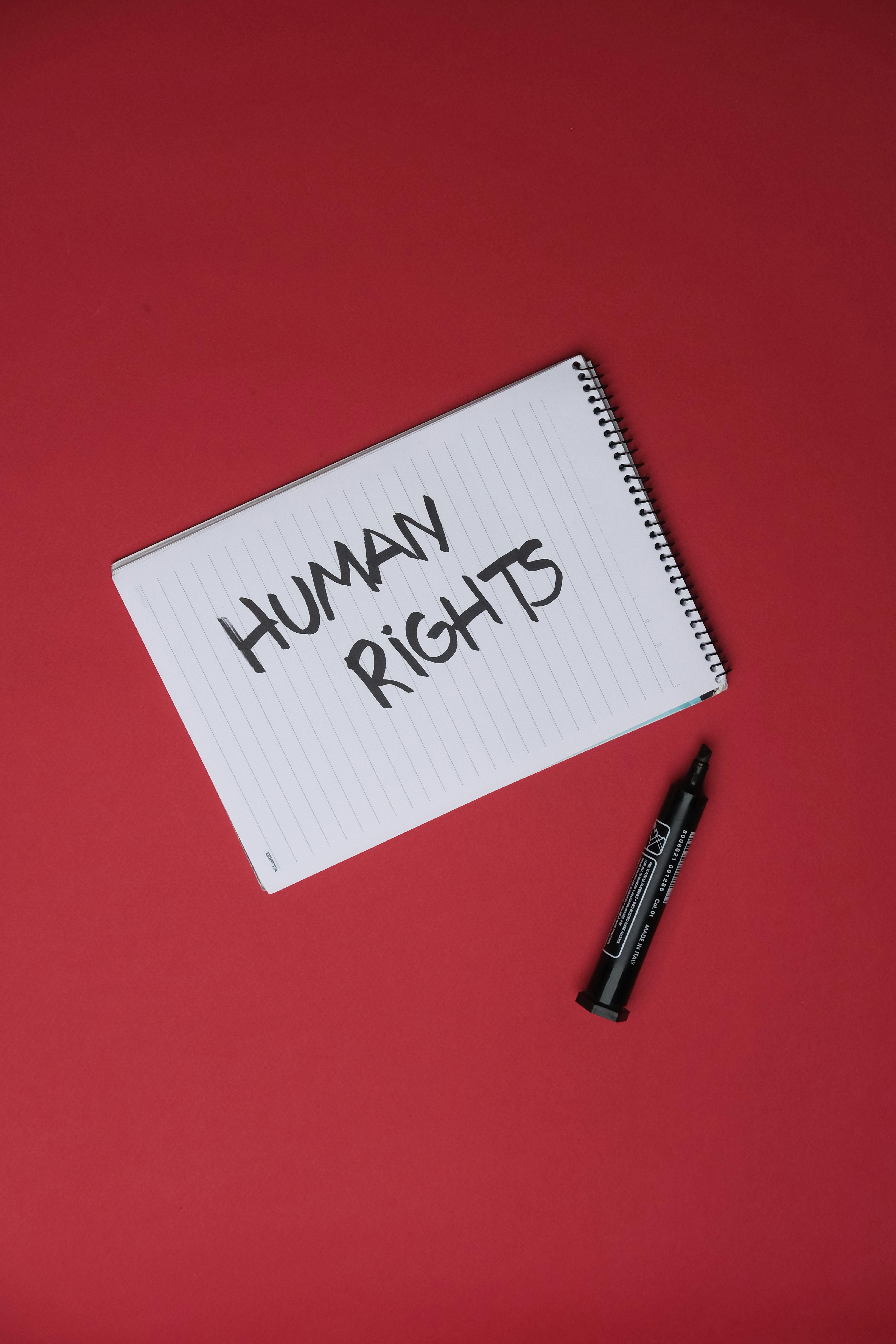 Human Rights Message on Notepad with Marker · Free Stock Photo