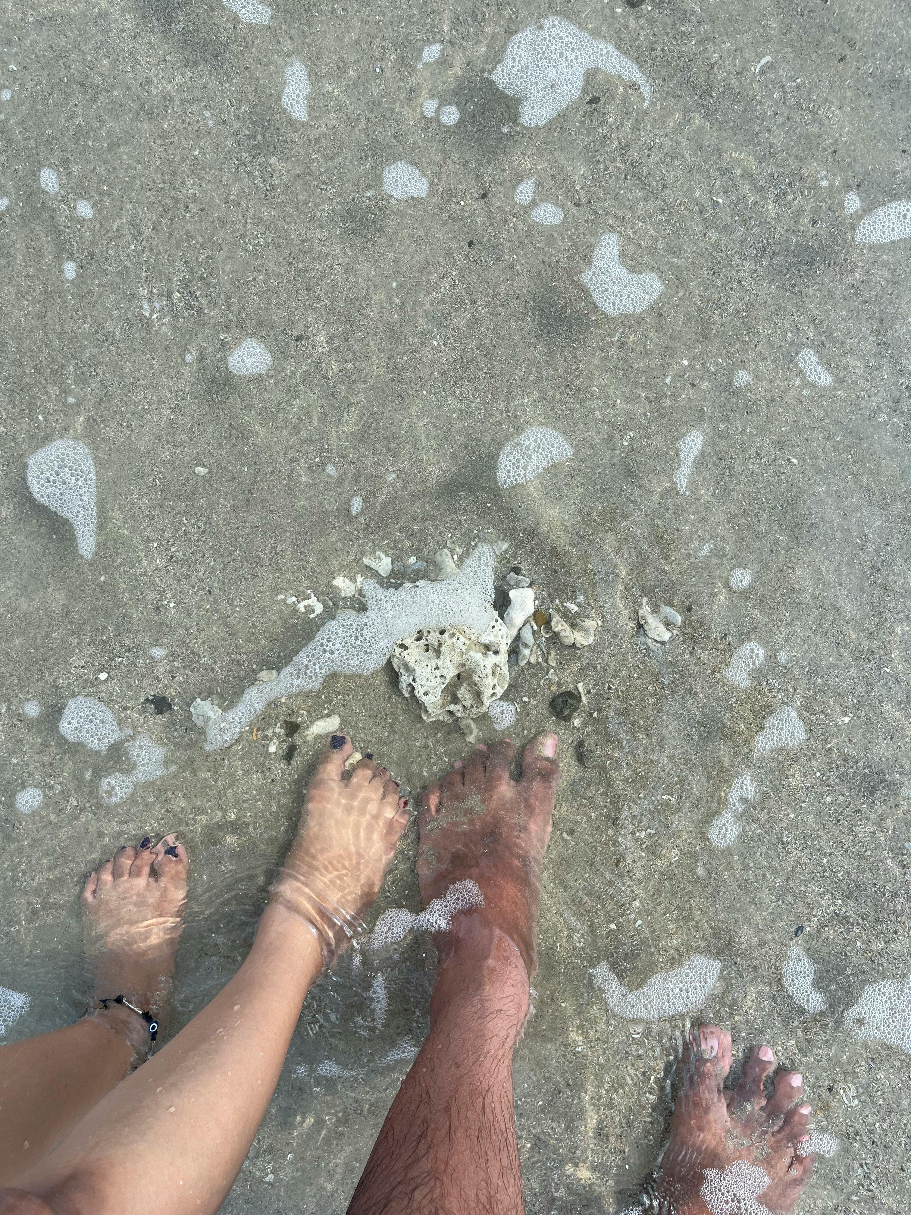 Feet in Ocean Waves by the Seashore · Free Stock Photo