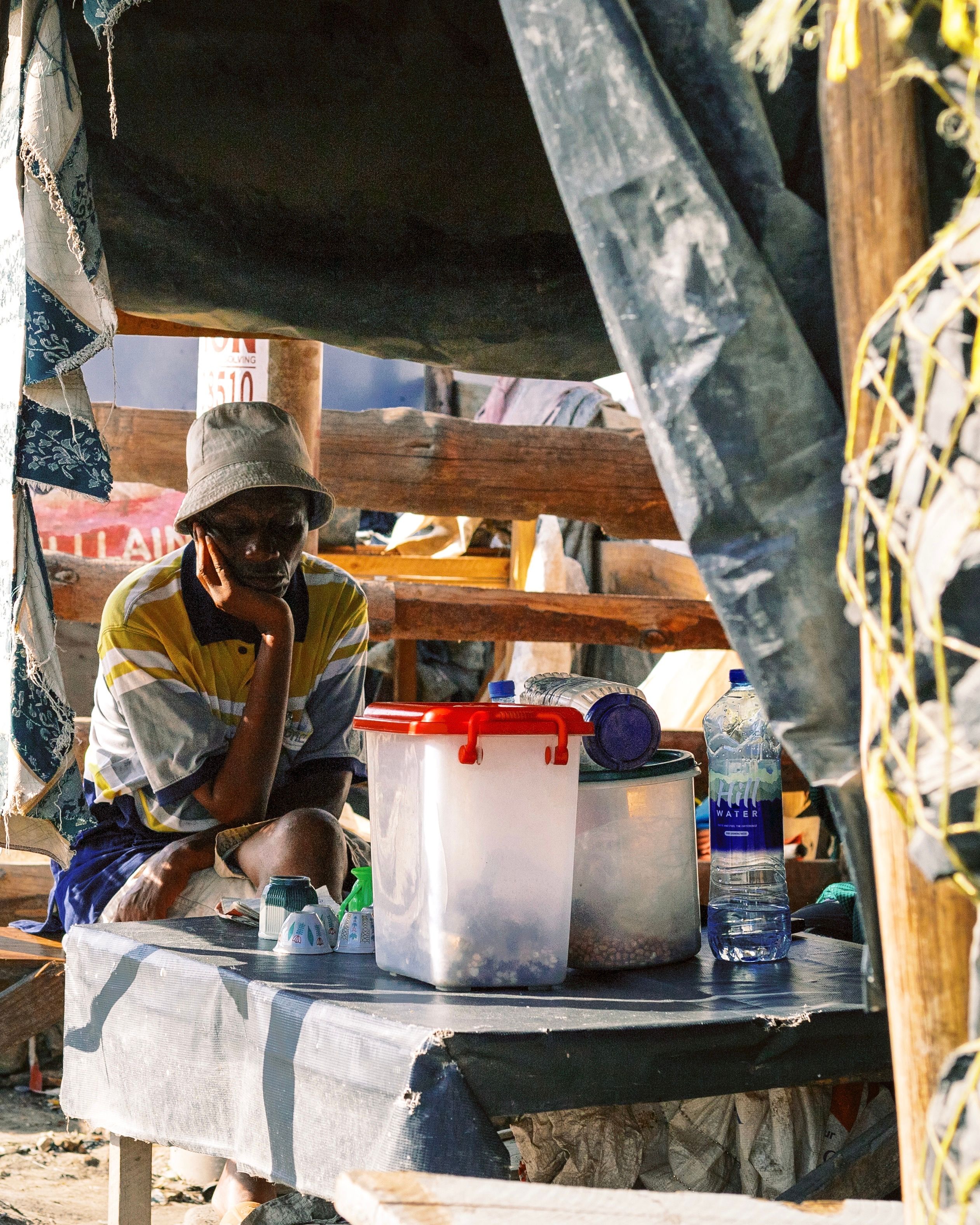 Street Vendor in Rustic Urban Setting · Free Stock Photo