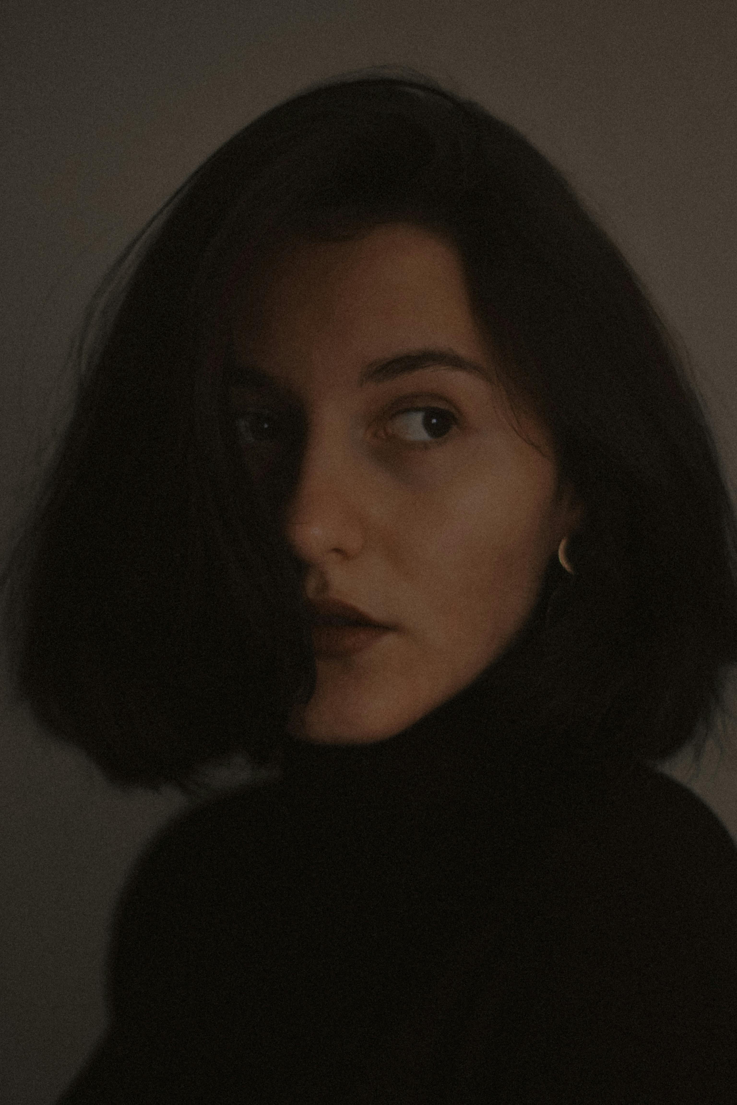 Moody Portrait of Woman in Low Light · Free Stock Photo