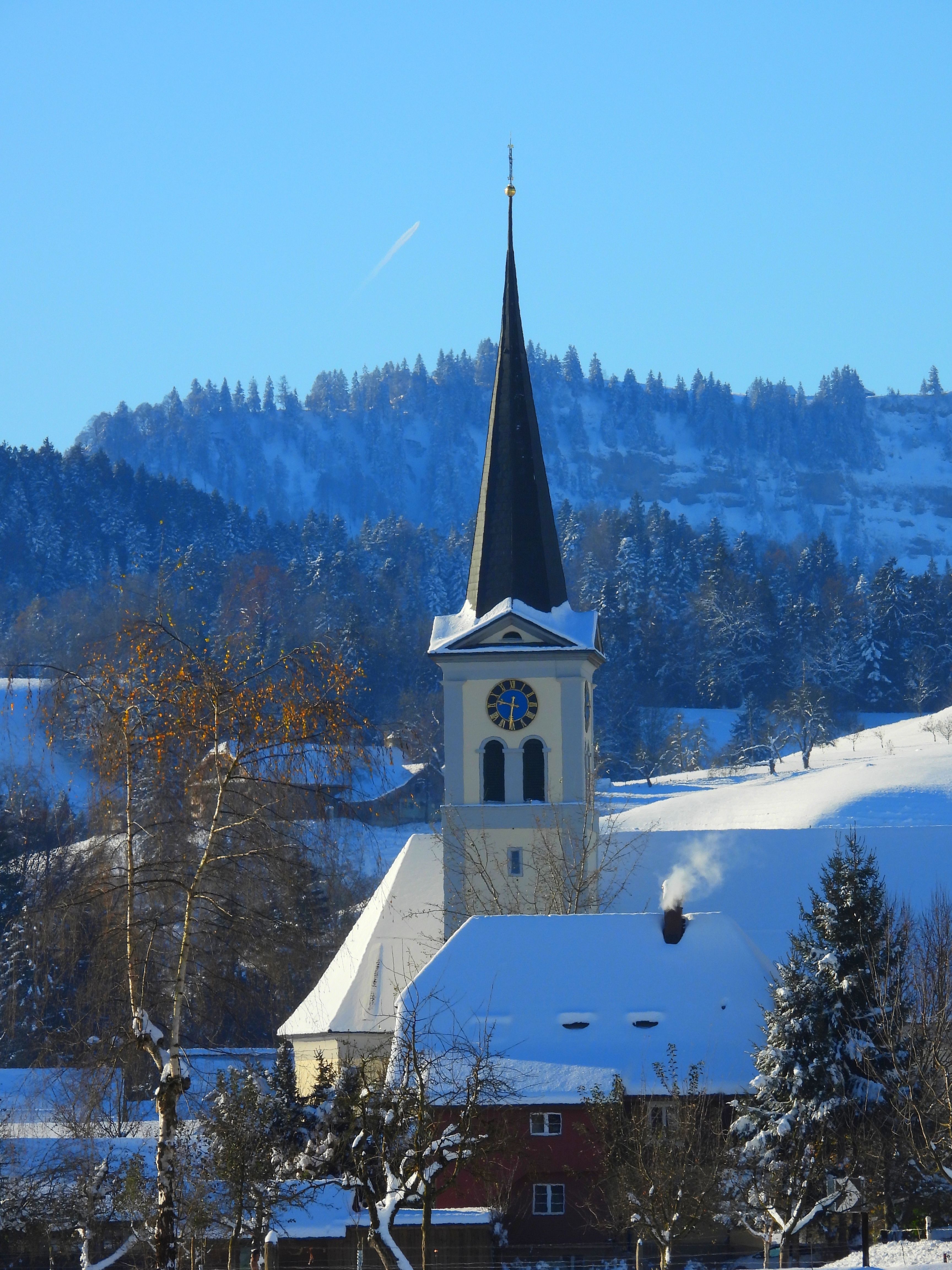 Snow-Covered Church with Mountainous Backdrop · Free Stock Photo