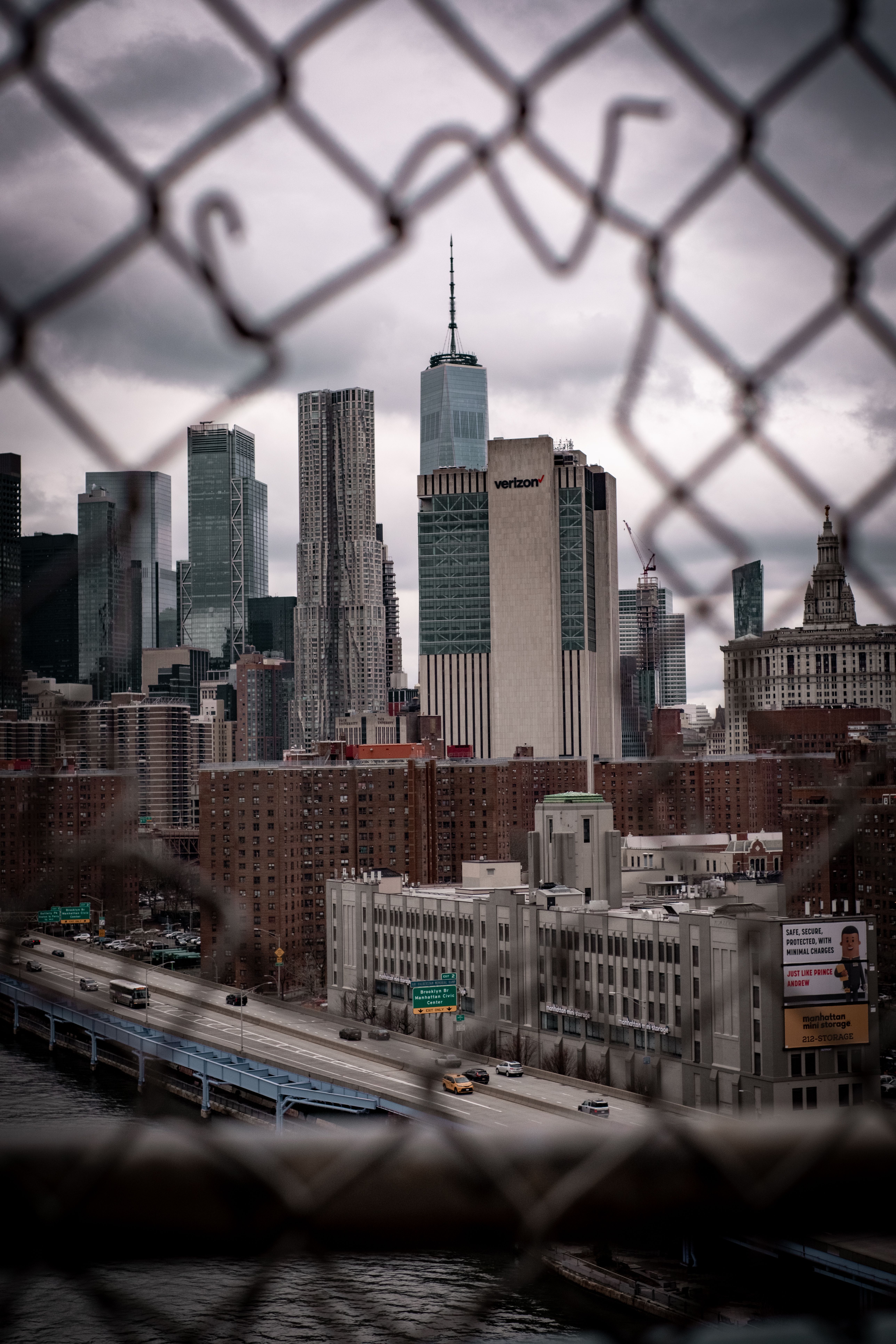 Dramatic NYC Skyline Through Chain Link Fence · Free Stock Photo