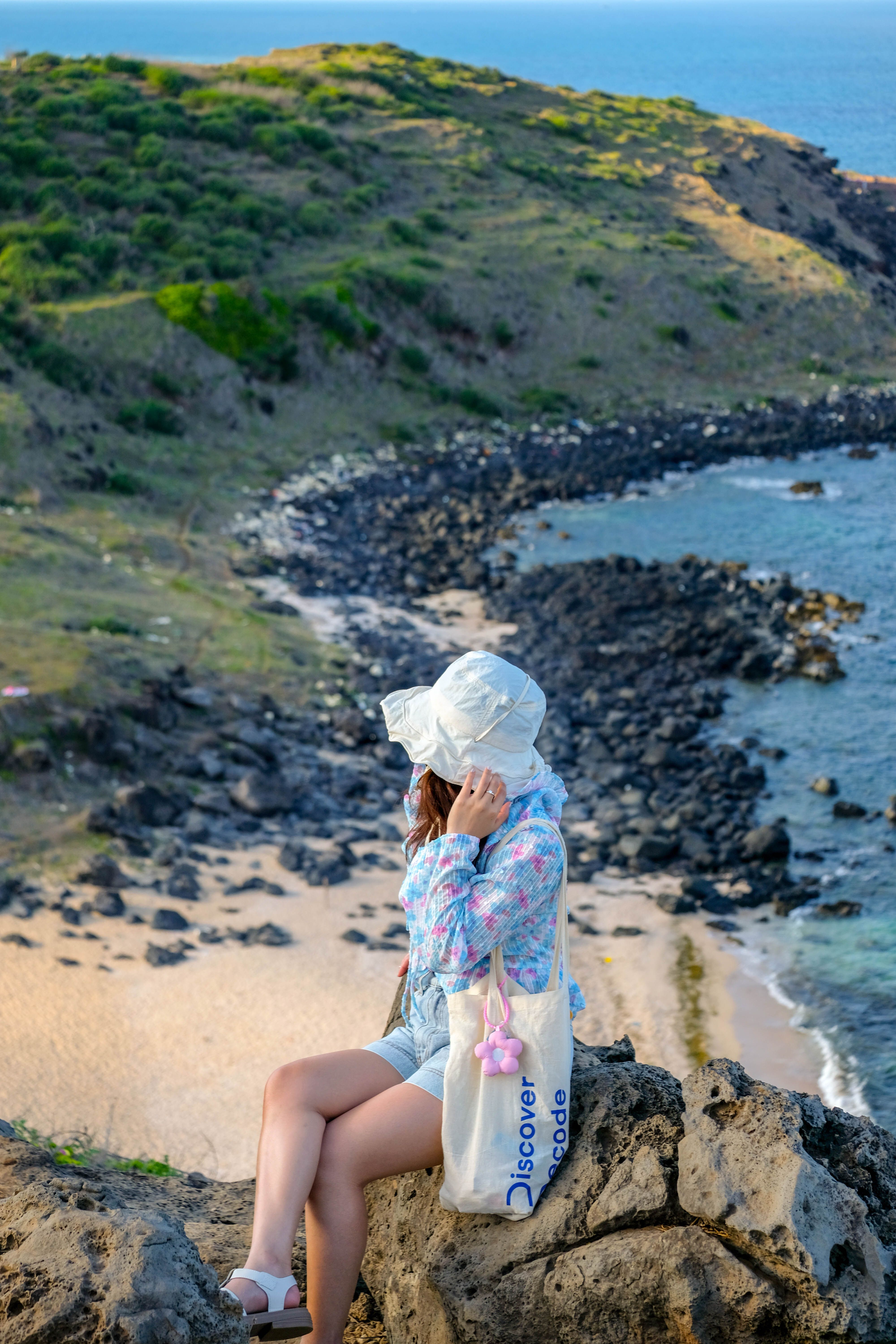 Young Woman Overlooking Rocky Beach Landscape · Free Stock Photo