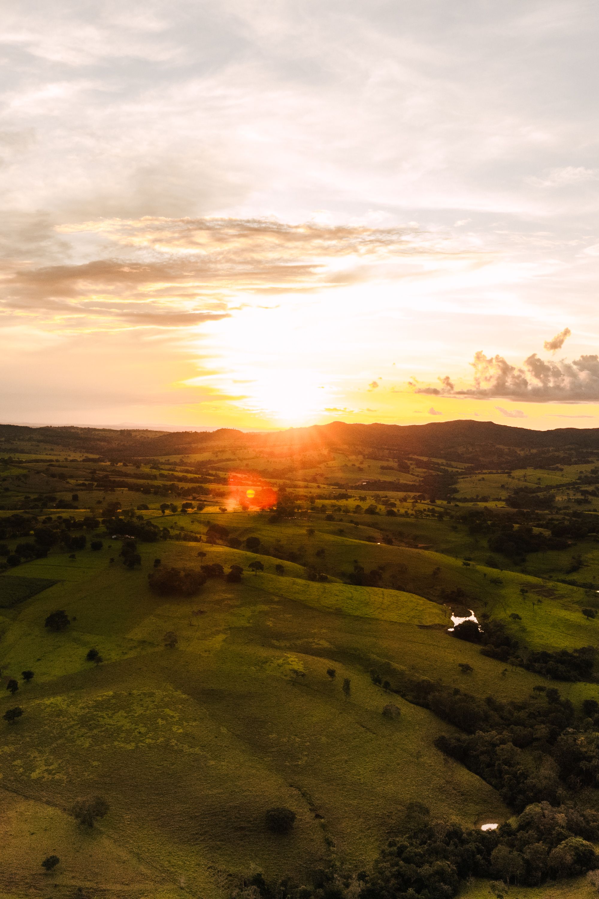 Stunning Golden Sunset Over Rolling Hills · Free Stock Photo