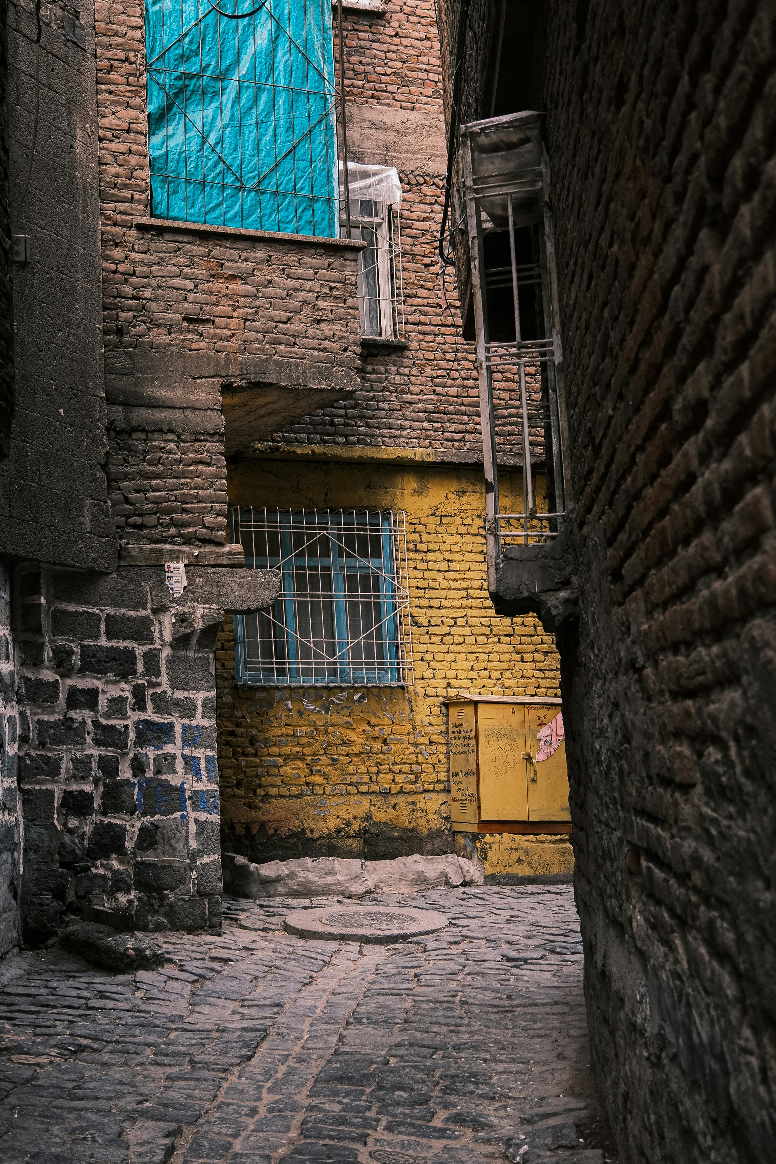 Urban Alleyway with Textured Brick Buildings · Free Stock Photo
