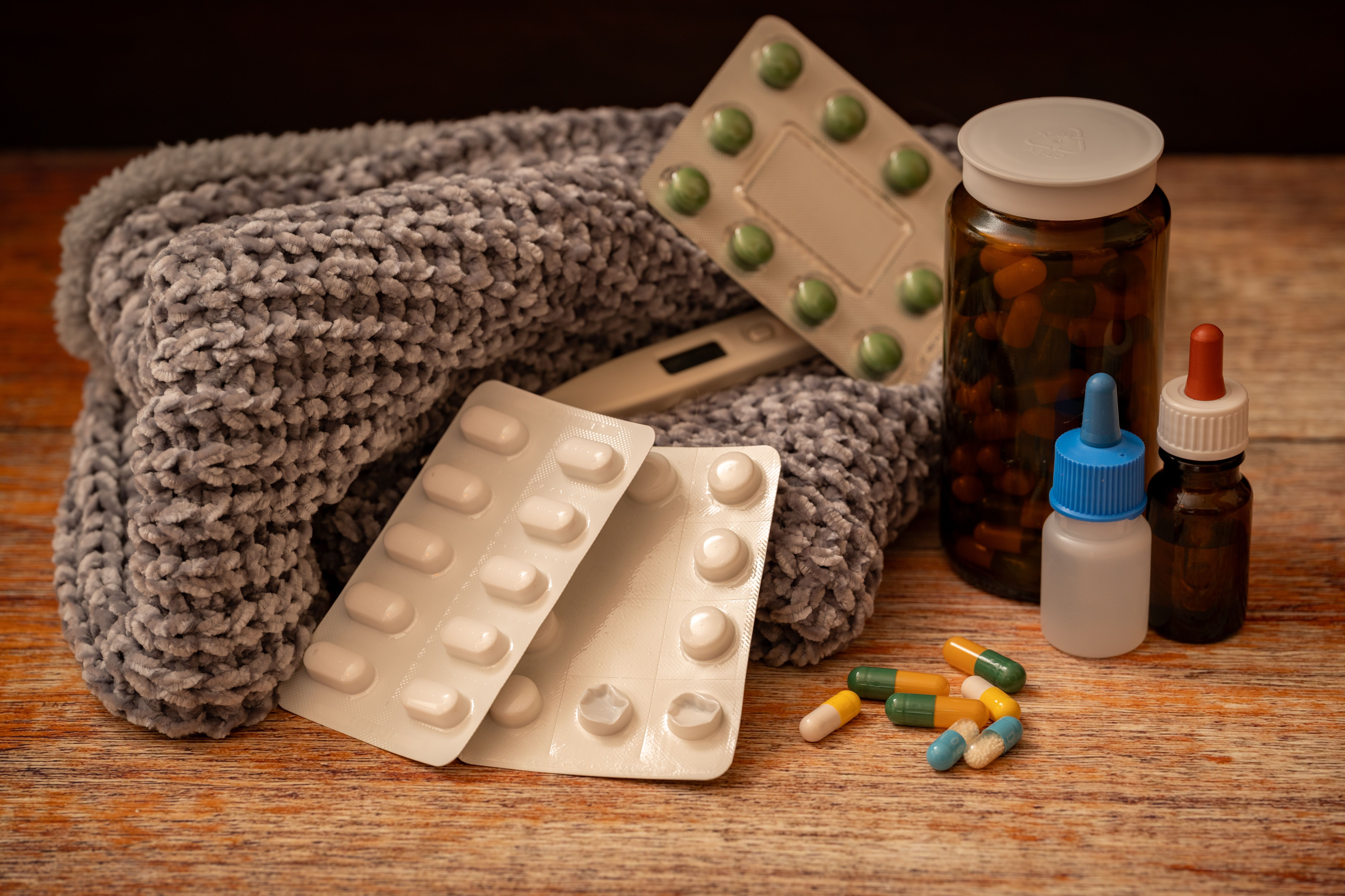 Cozy Home Remedy Setup with Medications and Scarf · Free Stock Photo