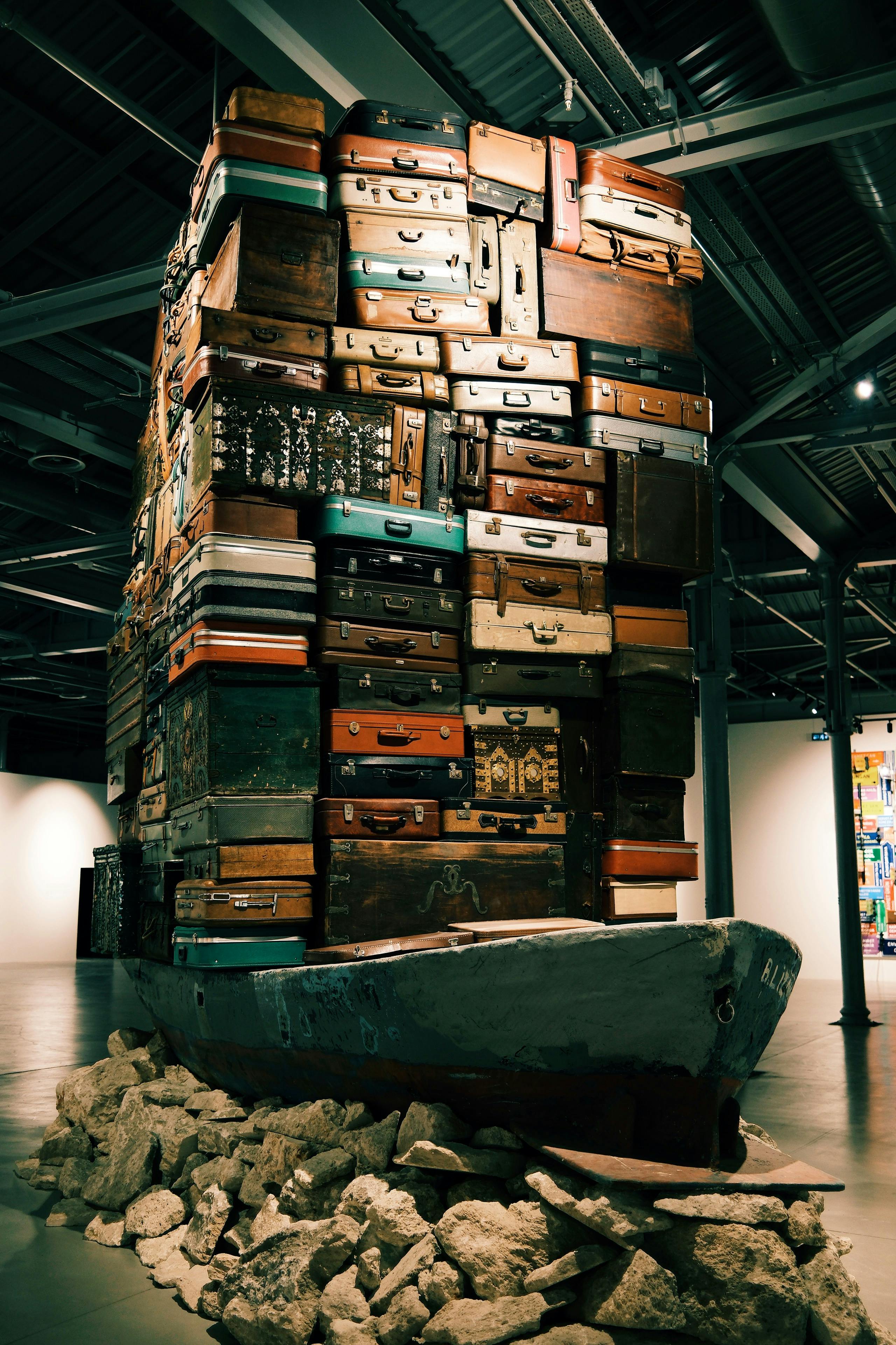 Stacked Suitcases Art Installation in Gallery · Free Stock Photo