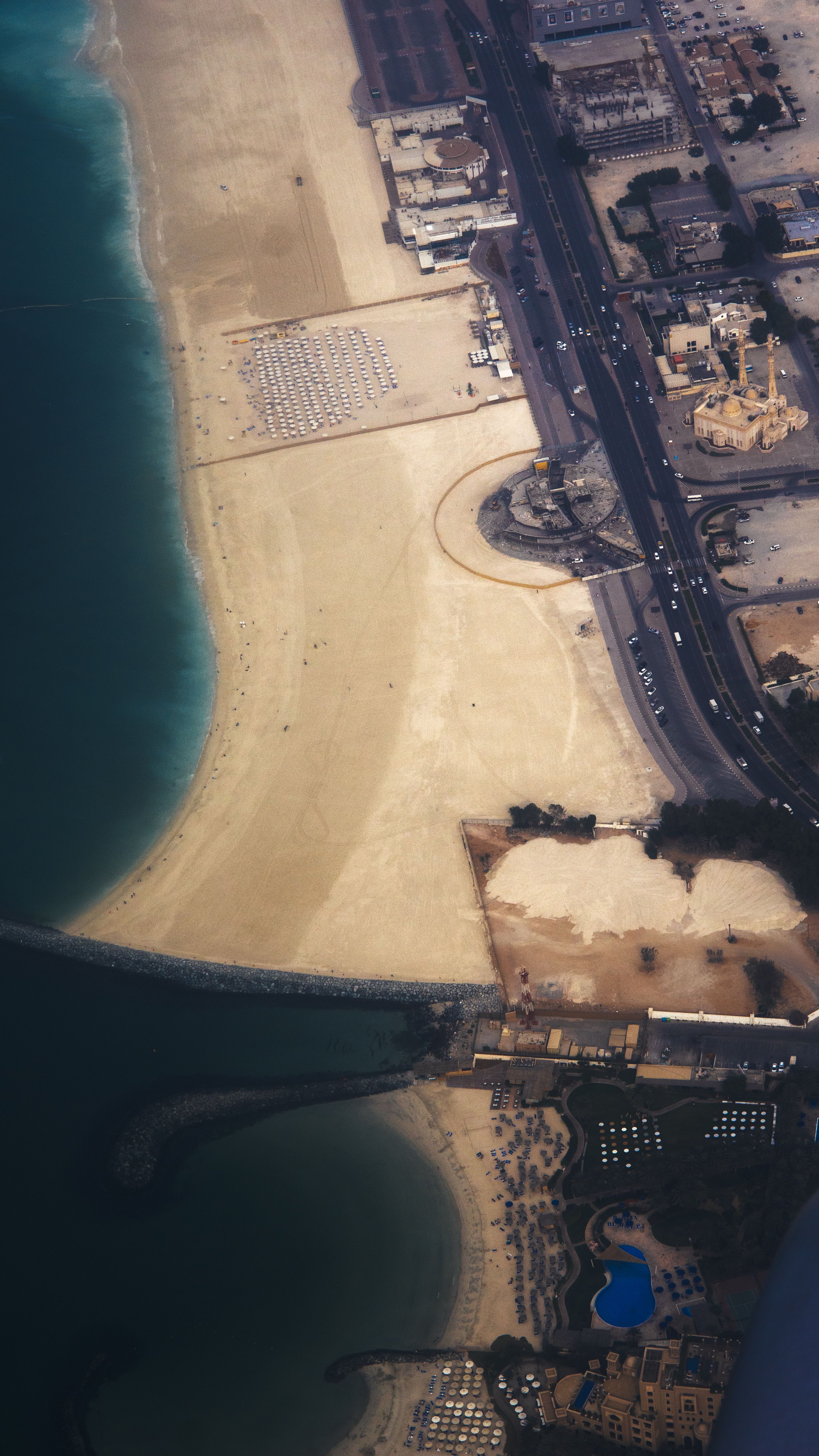 Aerial View of Coastal Beach and Urban Landscape · Free Stock Photo