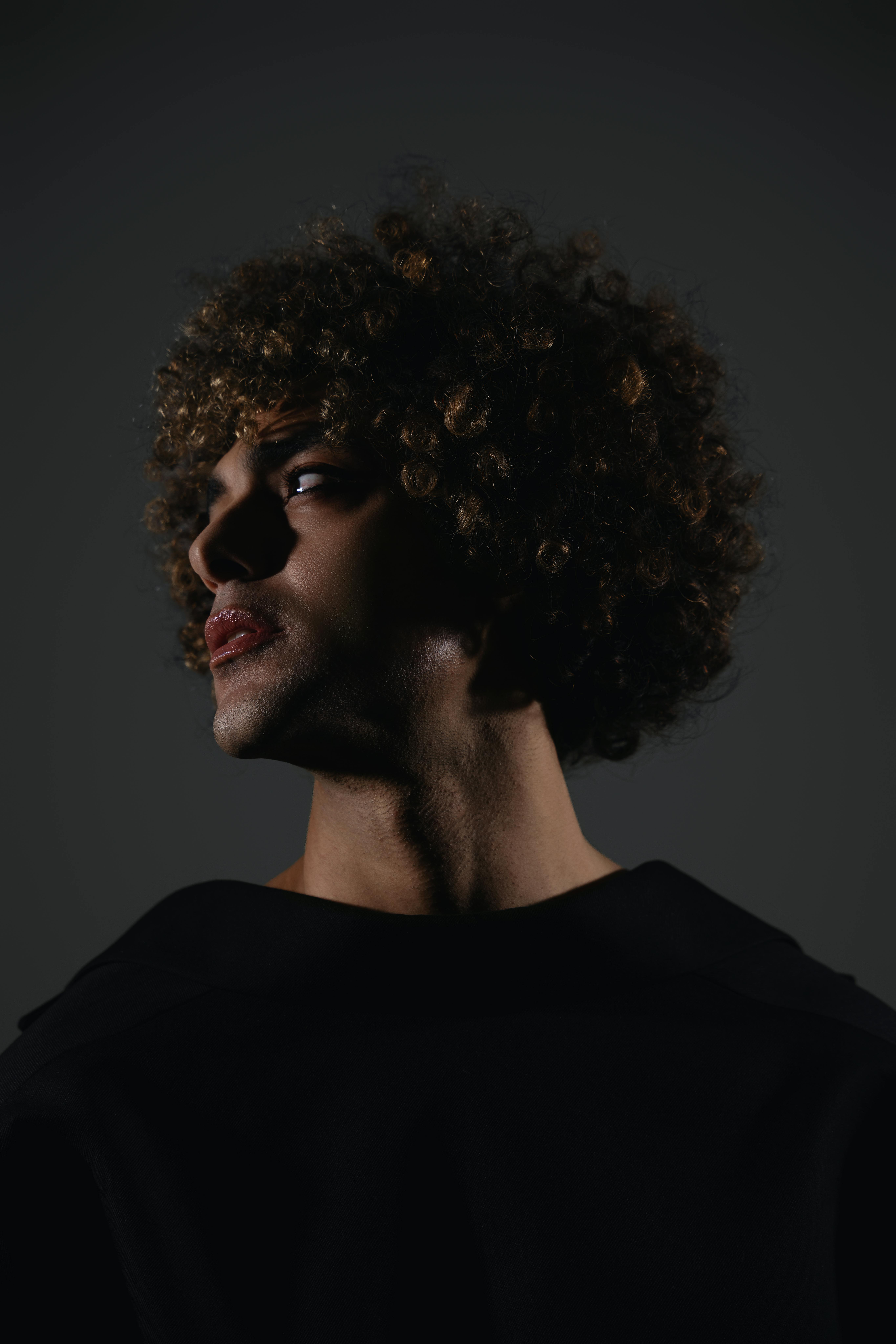 Dramatic Low-Key Male Portrait in Dark Tones · Free Stock Photo