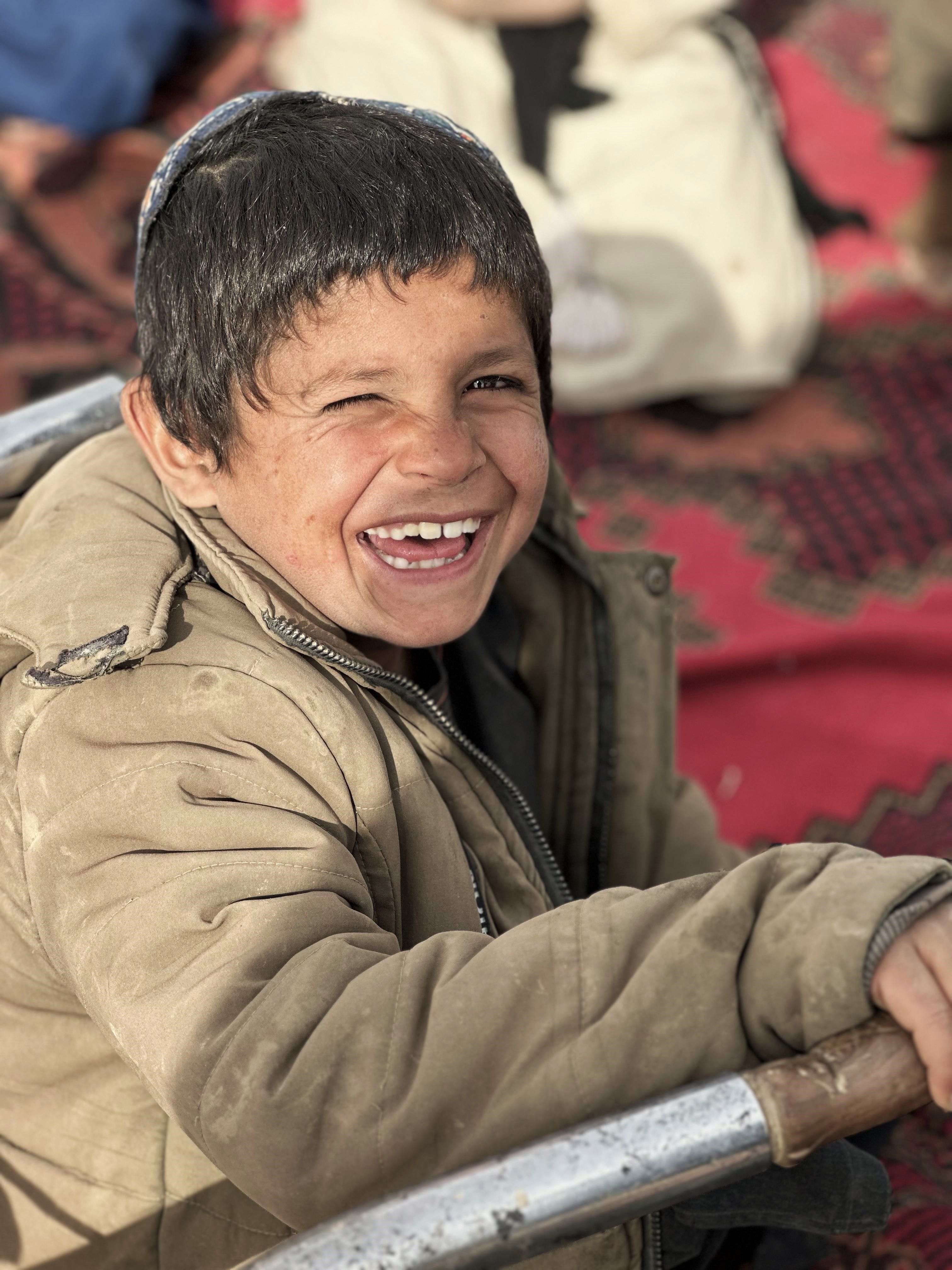 Joyful Child Smiling in Warm Winter Coat · Free Stock Photo